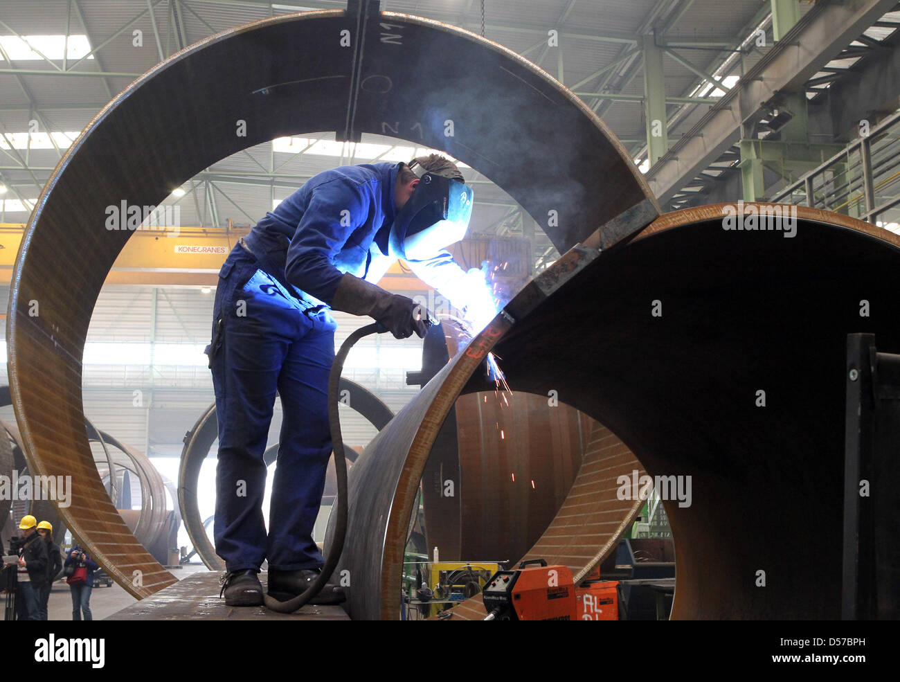 A staff member of EEW Special Pipe Conmstructions welds segments for an ...