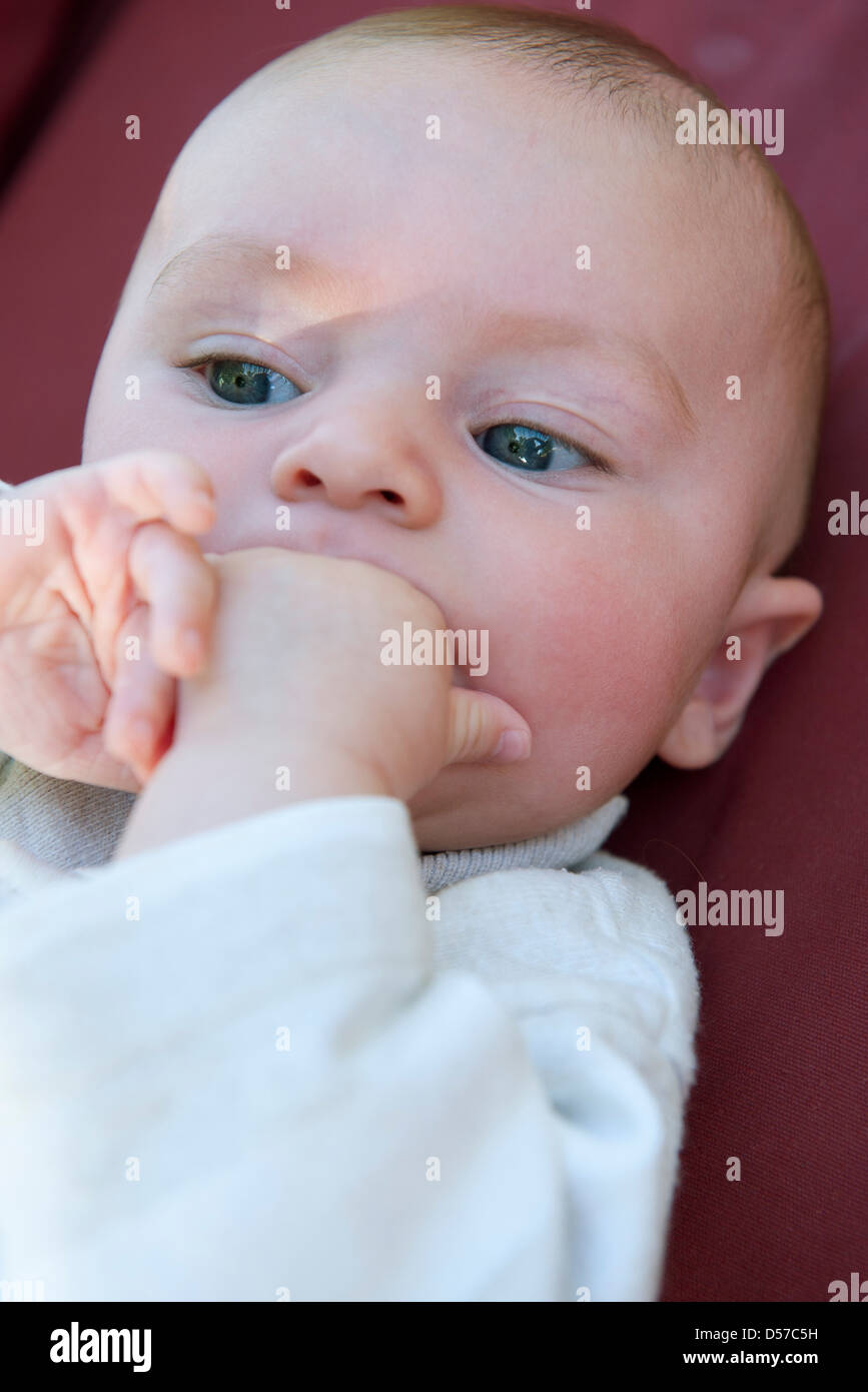 Baby biting hand, high angle view Stock Photo - Alamy