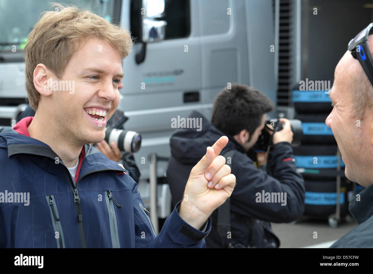 German driver Sebastian Vettel of Red Bull Racing smiles in the paddock ...