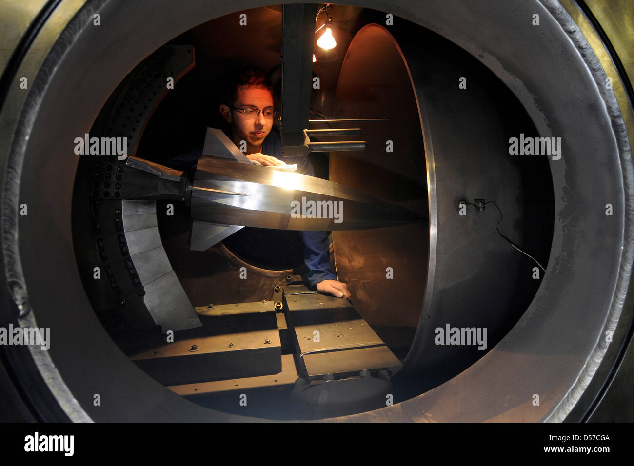 Engineer Mario Juenemann cleans the model of the new spacecraft Shefex ...