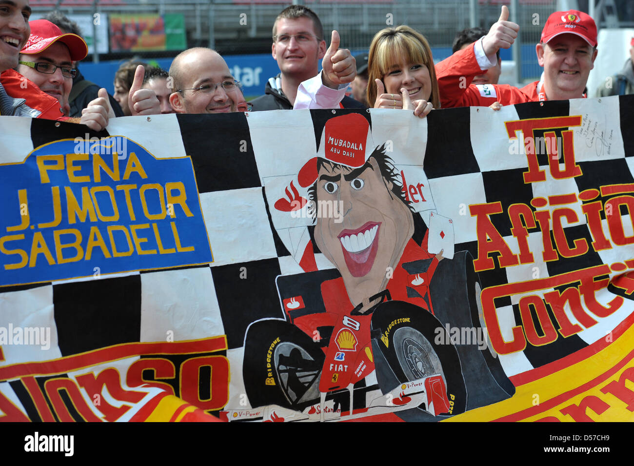 Fans of Spanish driver Fernando Alonso of Scuderia Ferrari cheer at ...