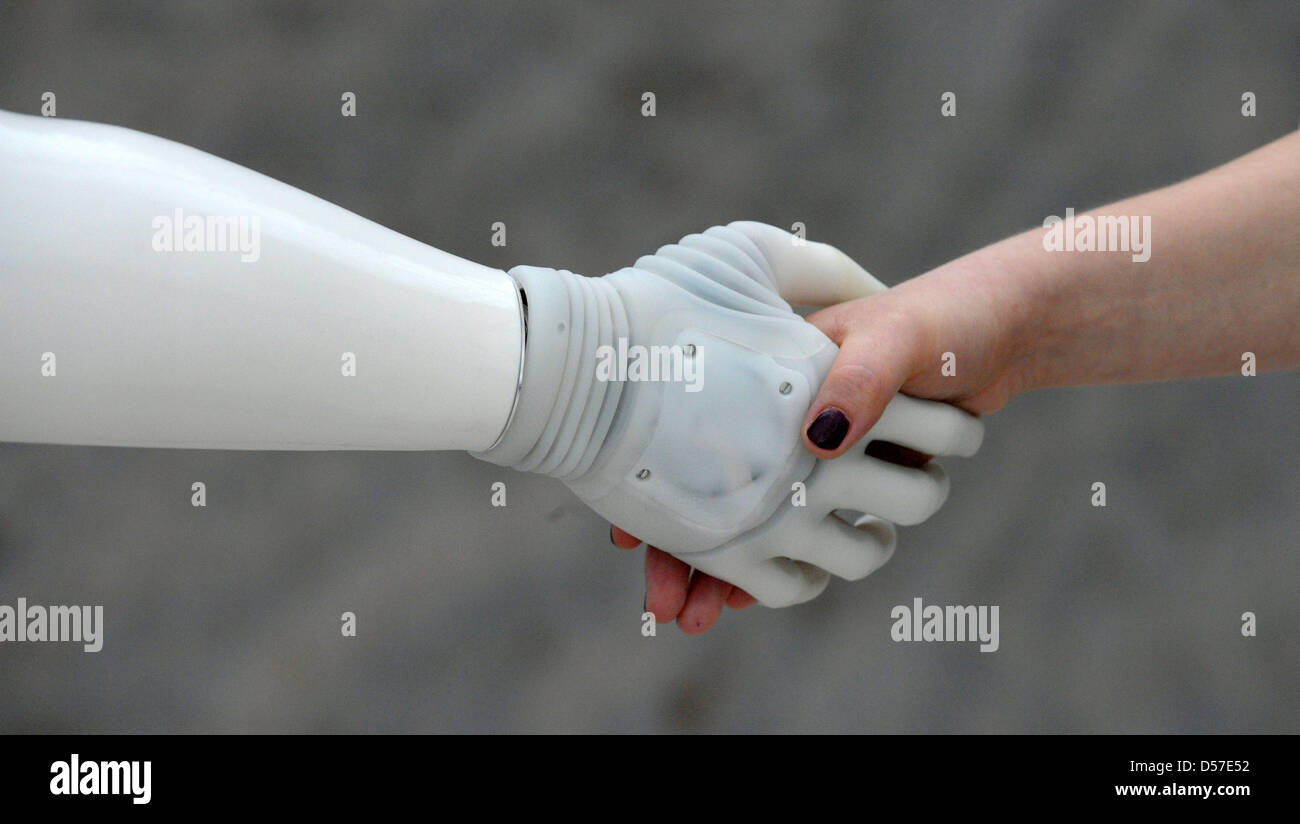The new hand prosthesis 'Michelangelo' holds another hand during a ...