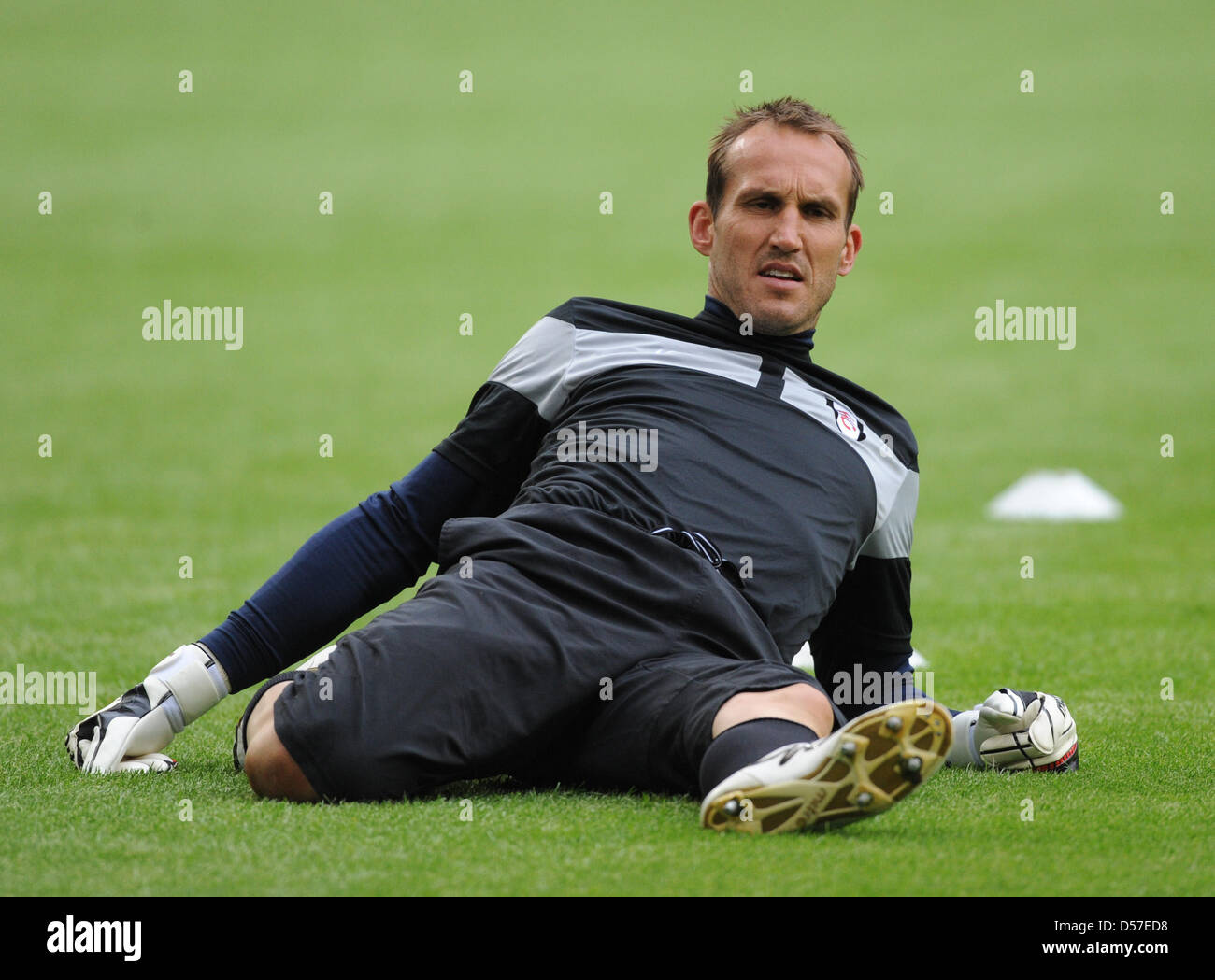 Fulham's goalkeeper Mark Schwarzer stretches during the training ...