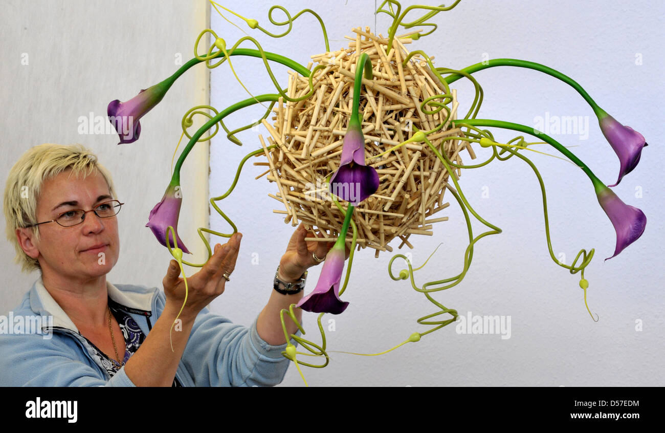 A florist, Birgit Metschulat, works on a decoration for the summer ...