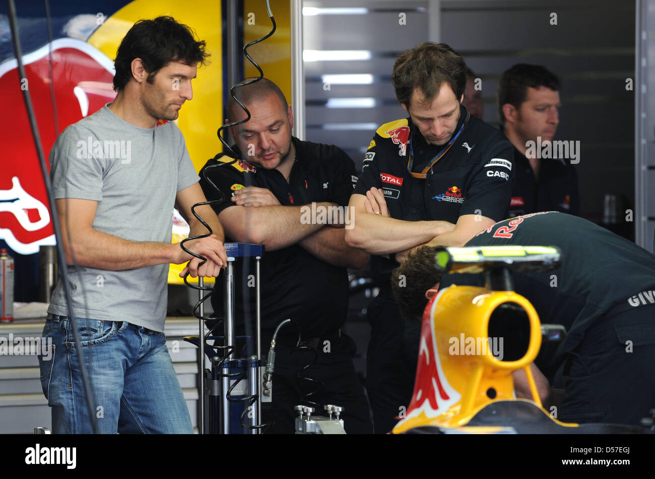 Australian driver Mark Webber of Red Bull Racing (L) inspects his race ...
