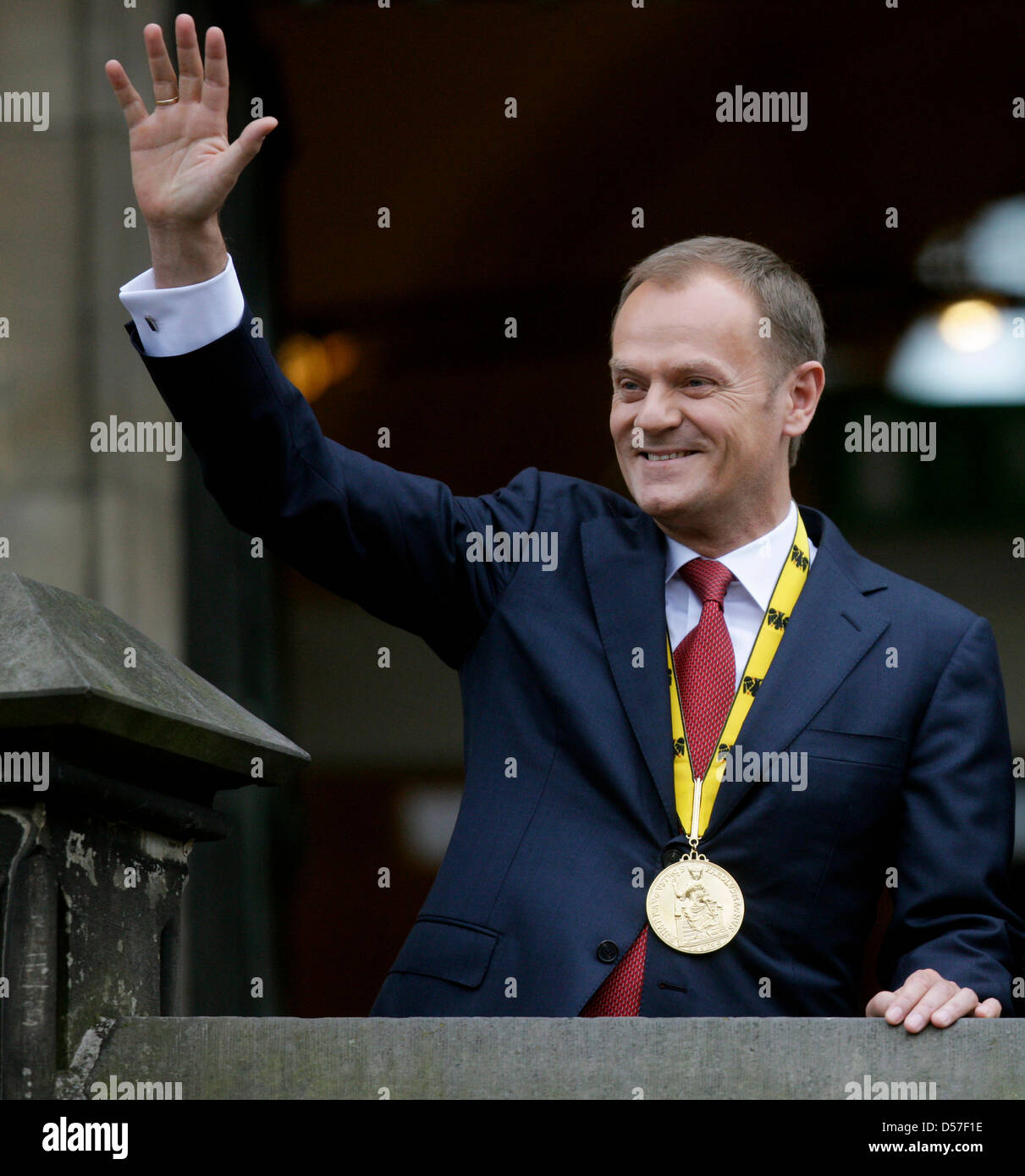 Polish Prime Minister Donald Tusk waves after the awarding ceremony of ...