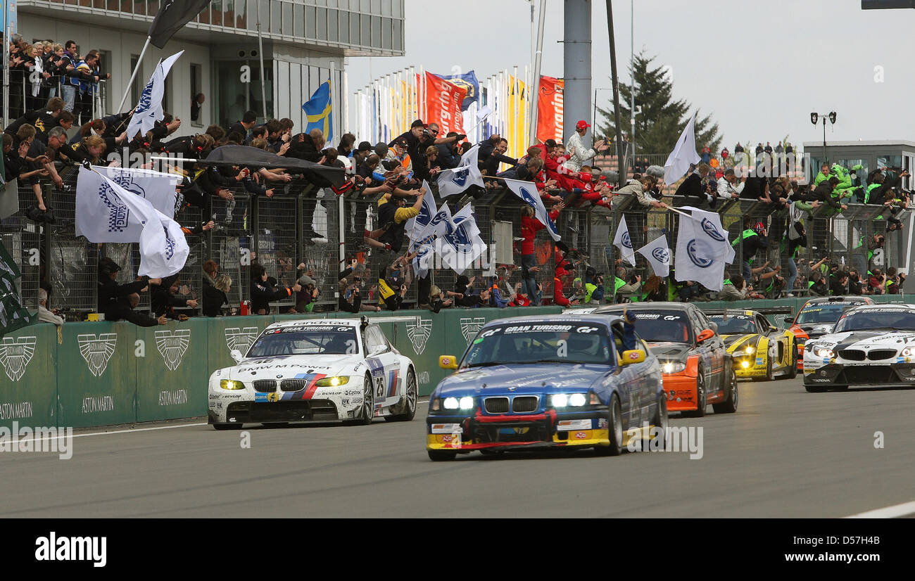 The BMW M3 of BMW factory team (L) wins the 24 Hours on Nurburgring ...