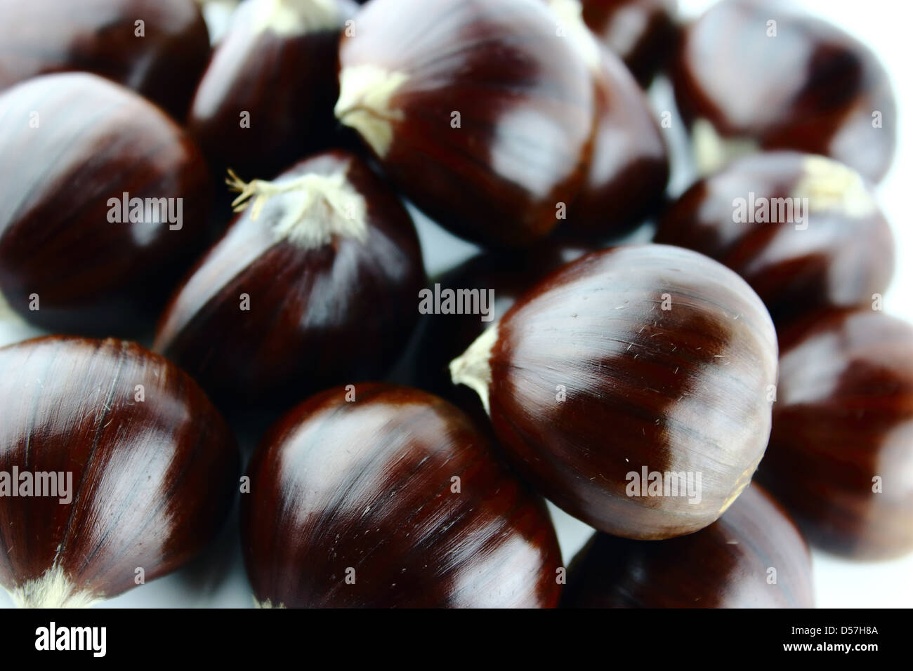 Sweet chestnuts on white background Stock Photo - Alamy