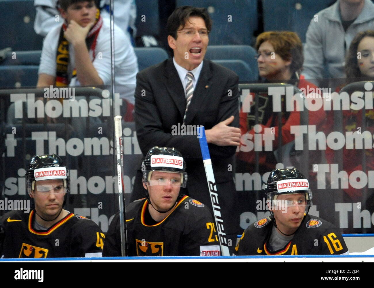 Germany's head coach Uwe Krupp (top) gives instructions from the boards ...