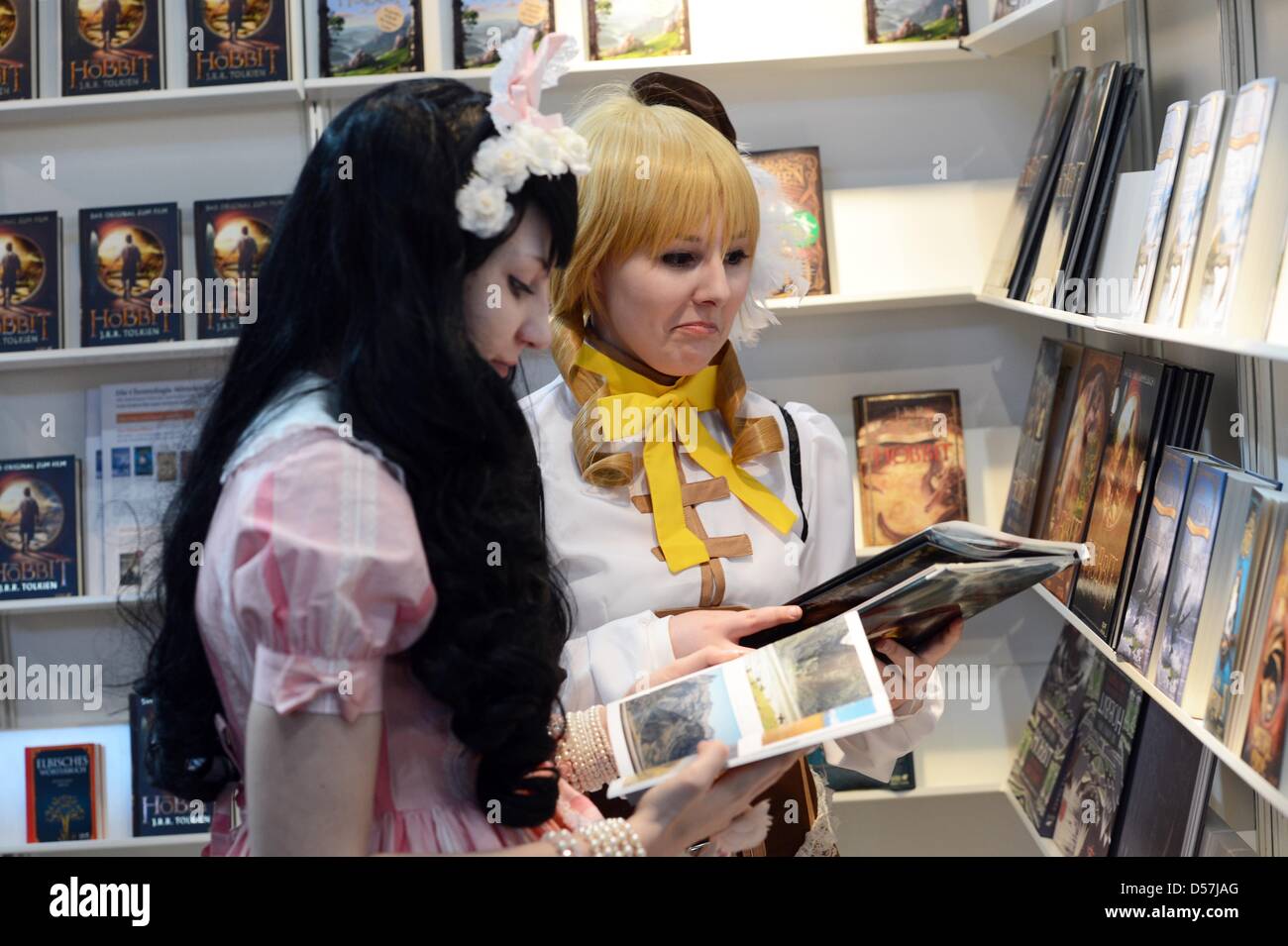Imaginatively dressed book fair attendees, known as Cosplayers, stand ...