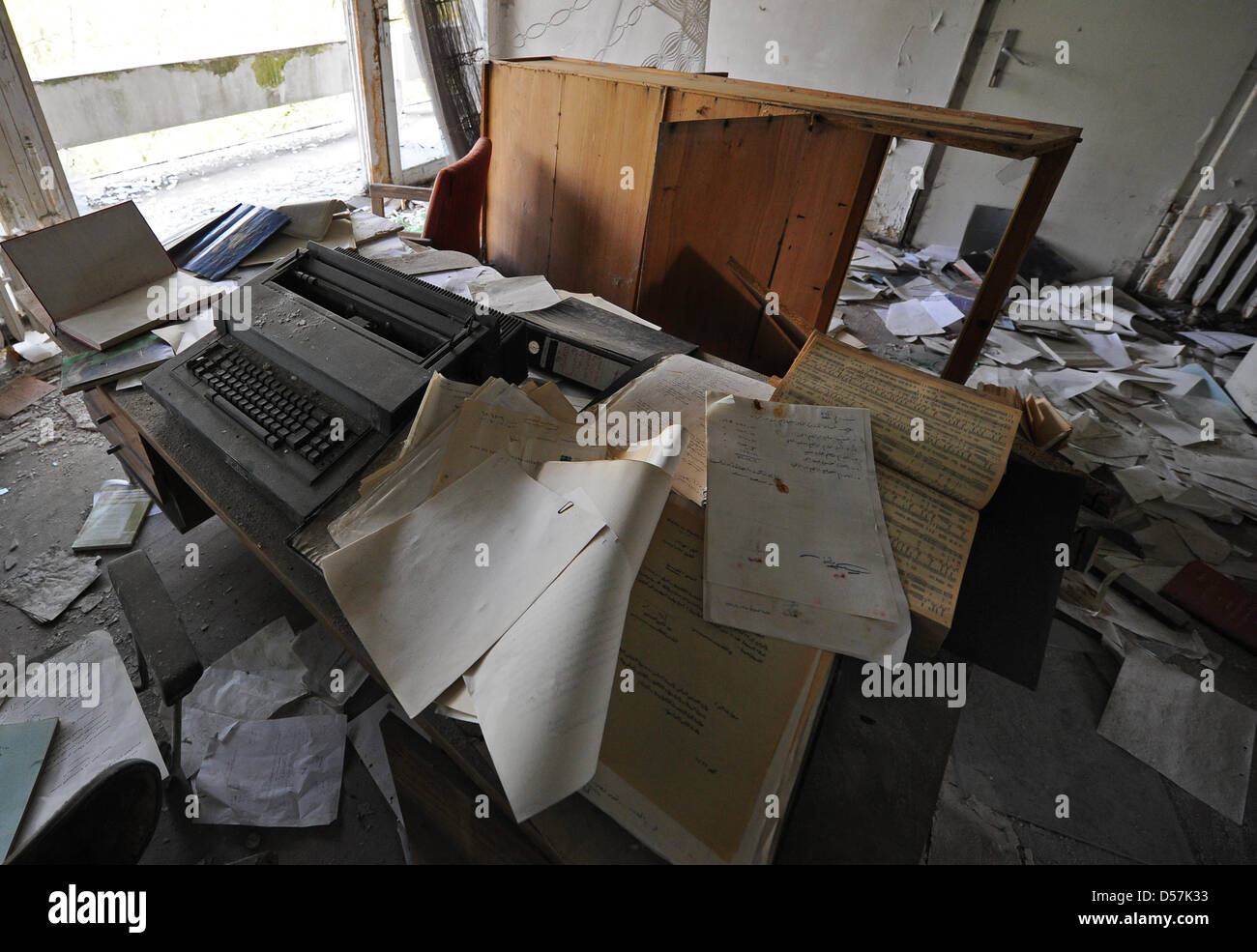 A destroyed room with typewriters, furniture and old documents pictured ...