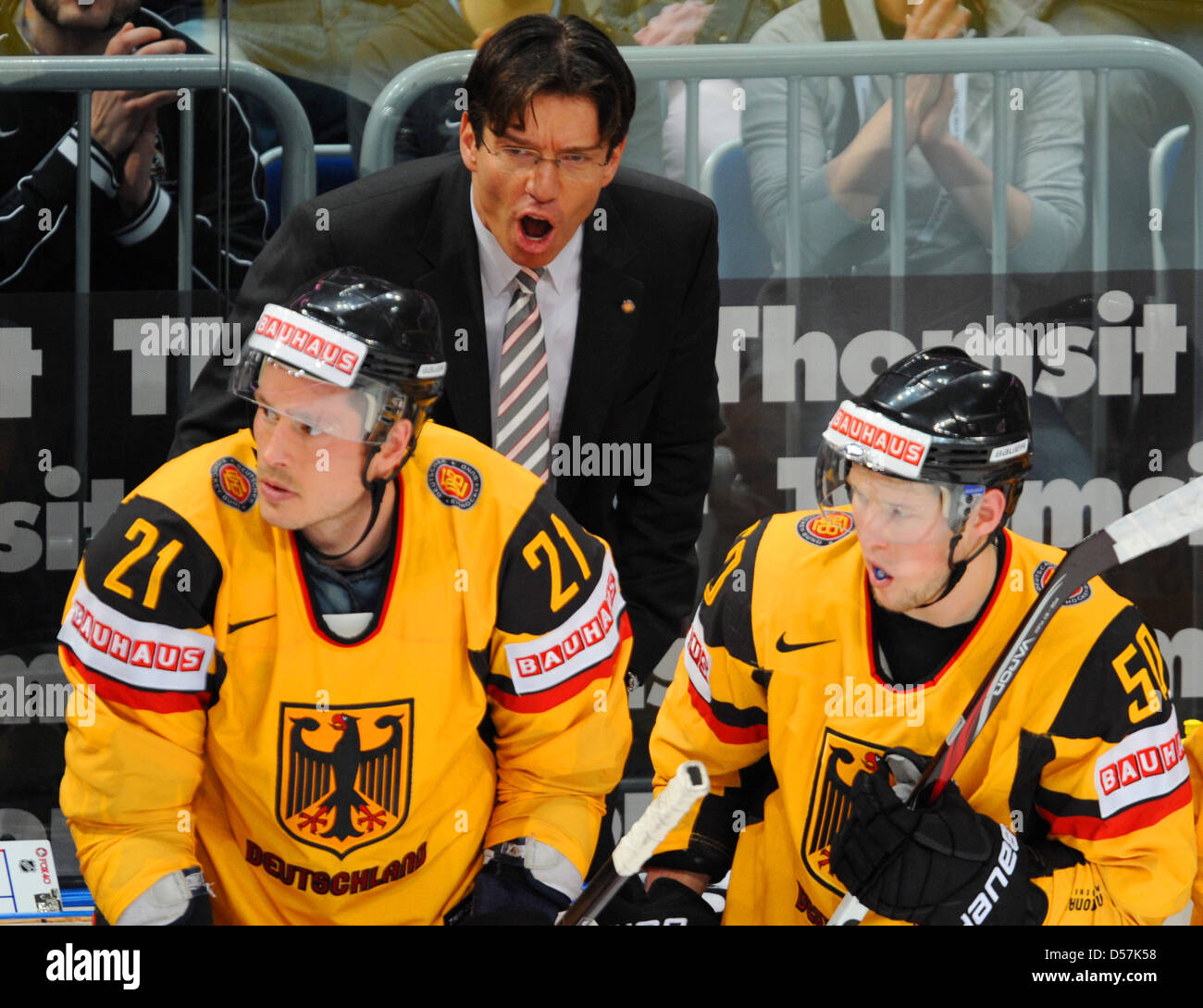 Germany's coach Uwe Krupp (C) cheers on Germany's John Tripp (L) and ...
