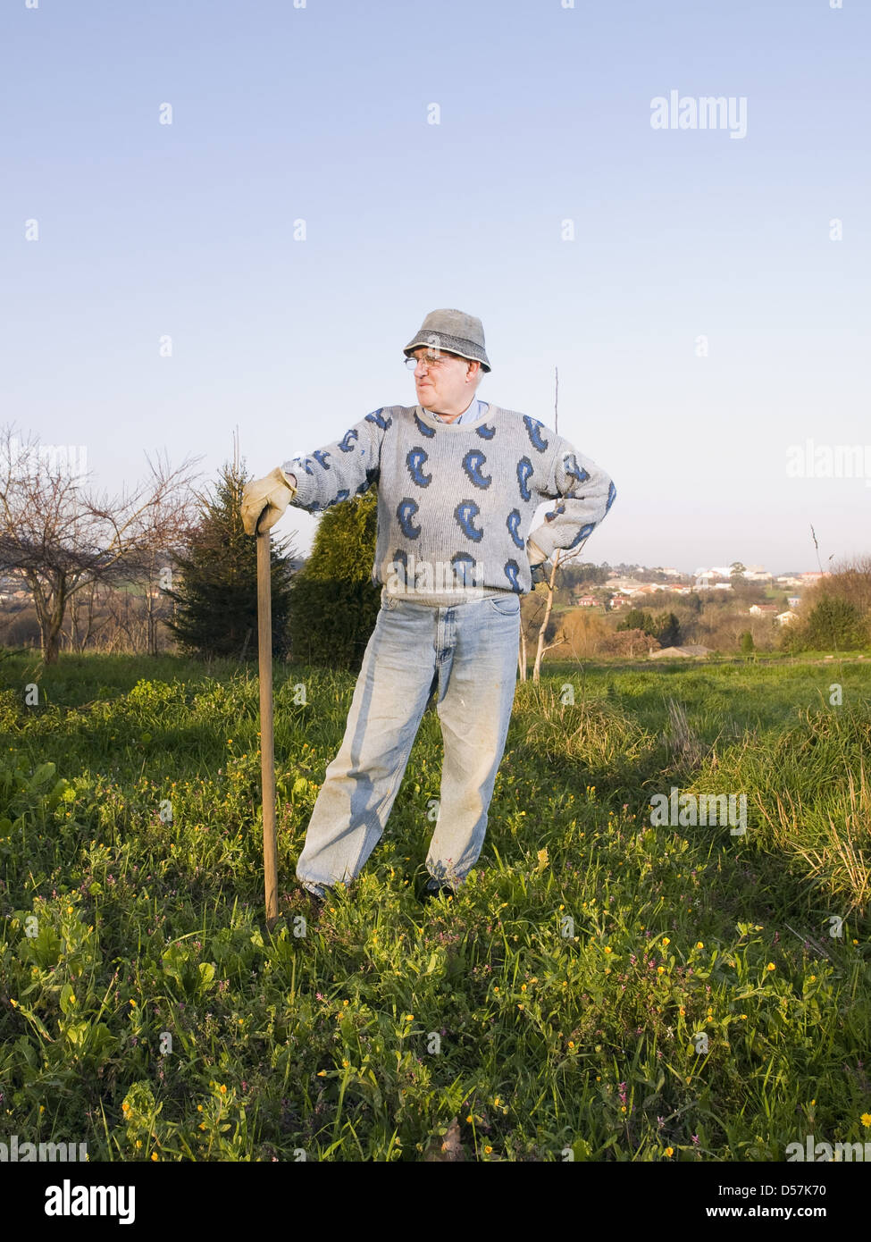 Man posing on their land farmer Stock Photo - Alamy