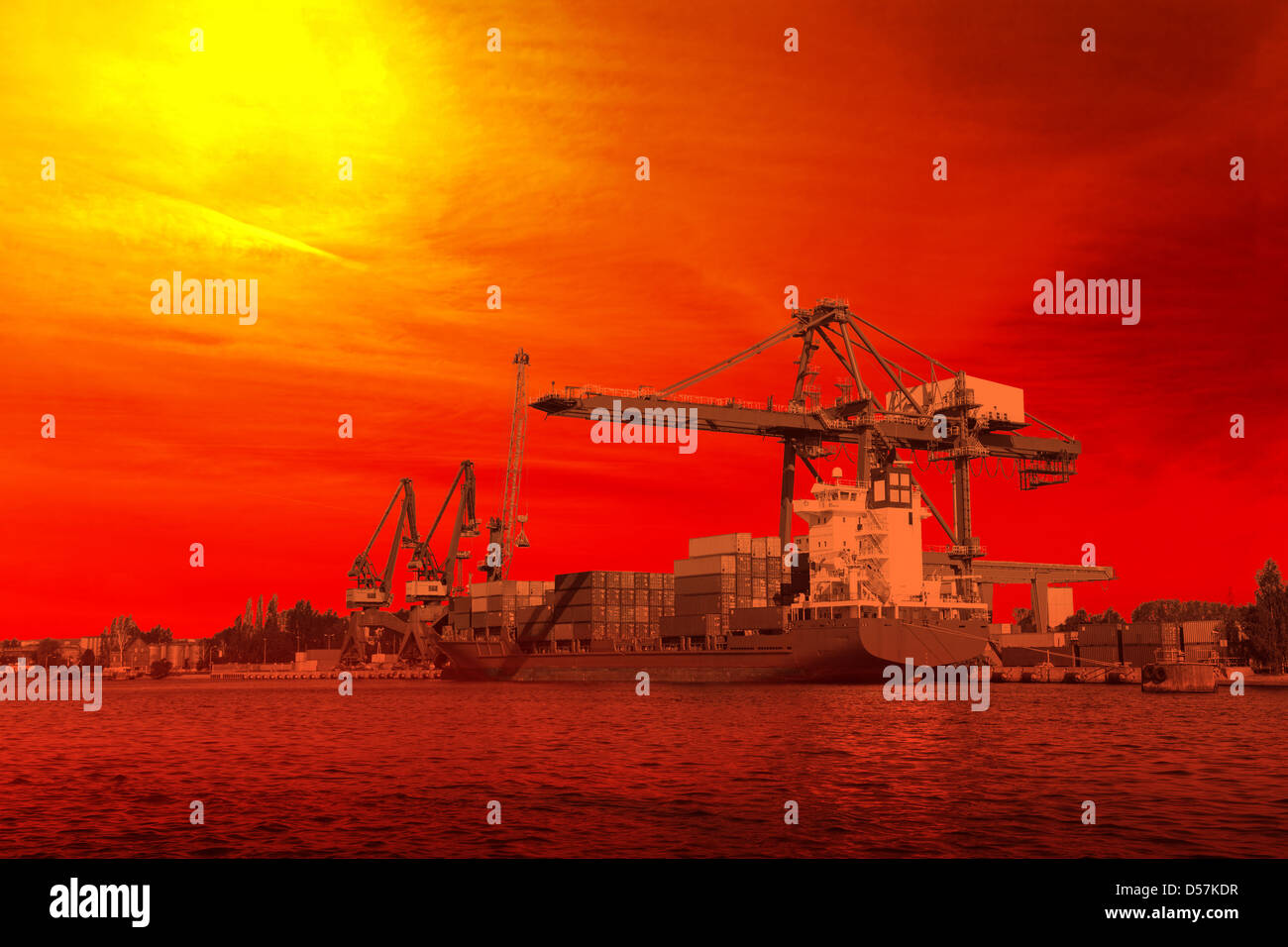 The Container Ship under loading in the harbor at sunset Stock Photo ...