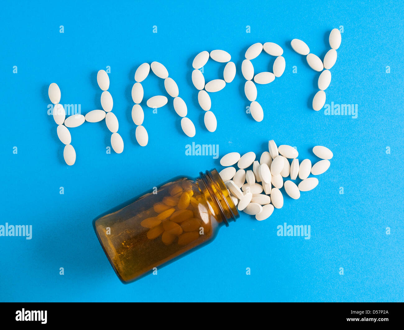 Word "happy" written whith pills on blue background. The photo is to ...