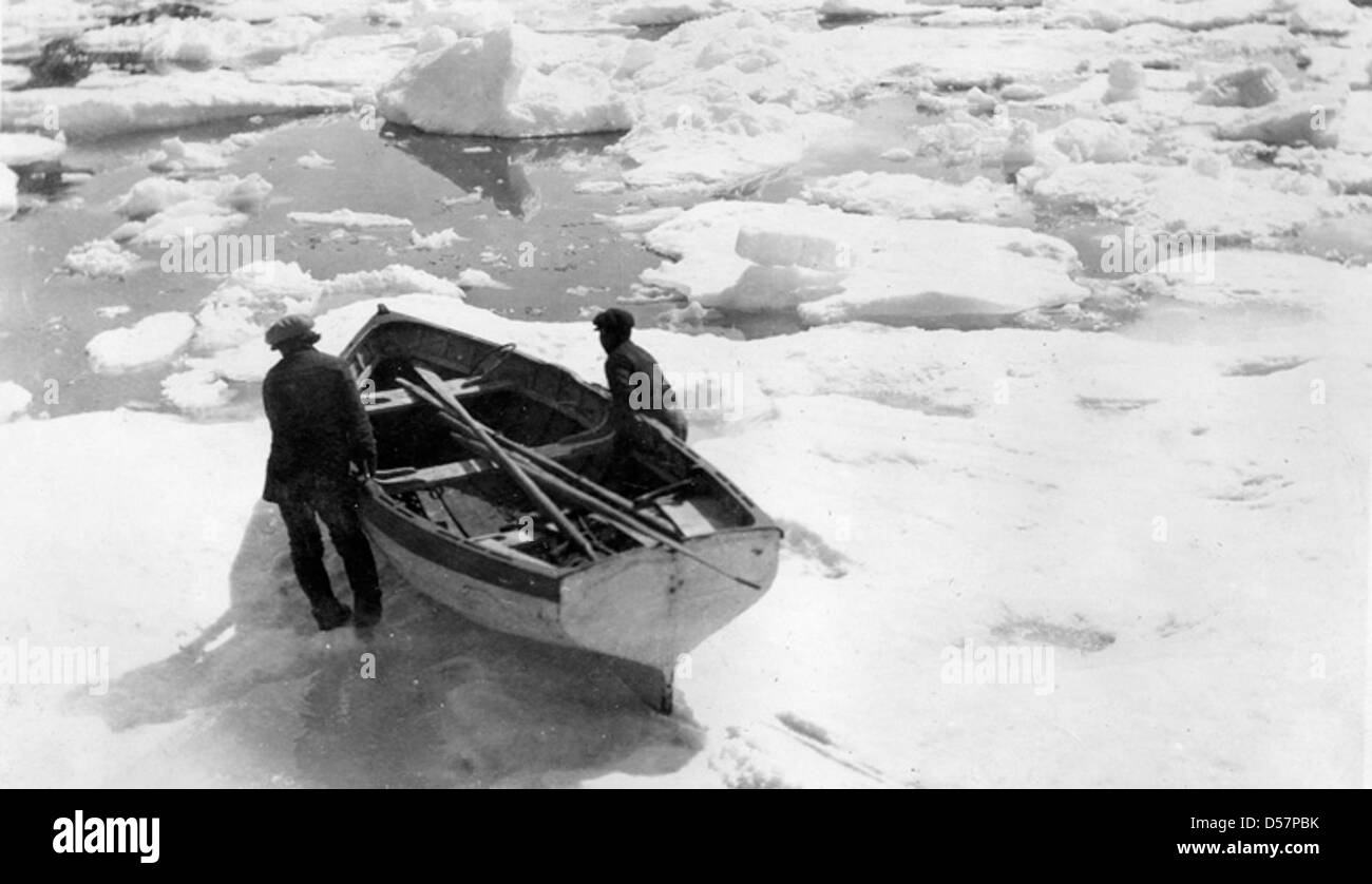 This historical photograph from 1921 shows two Inuit men taking a ...