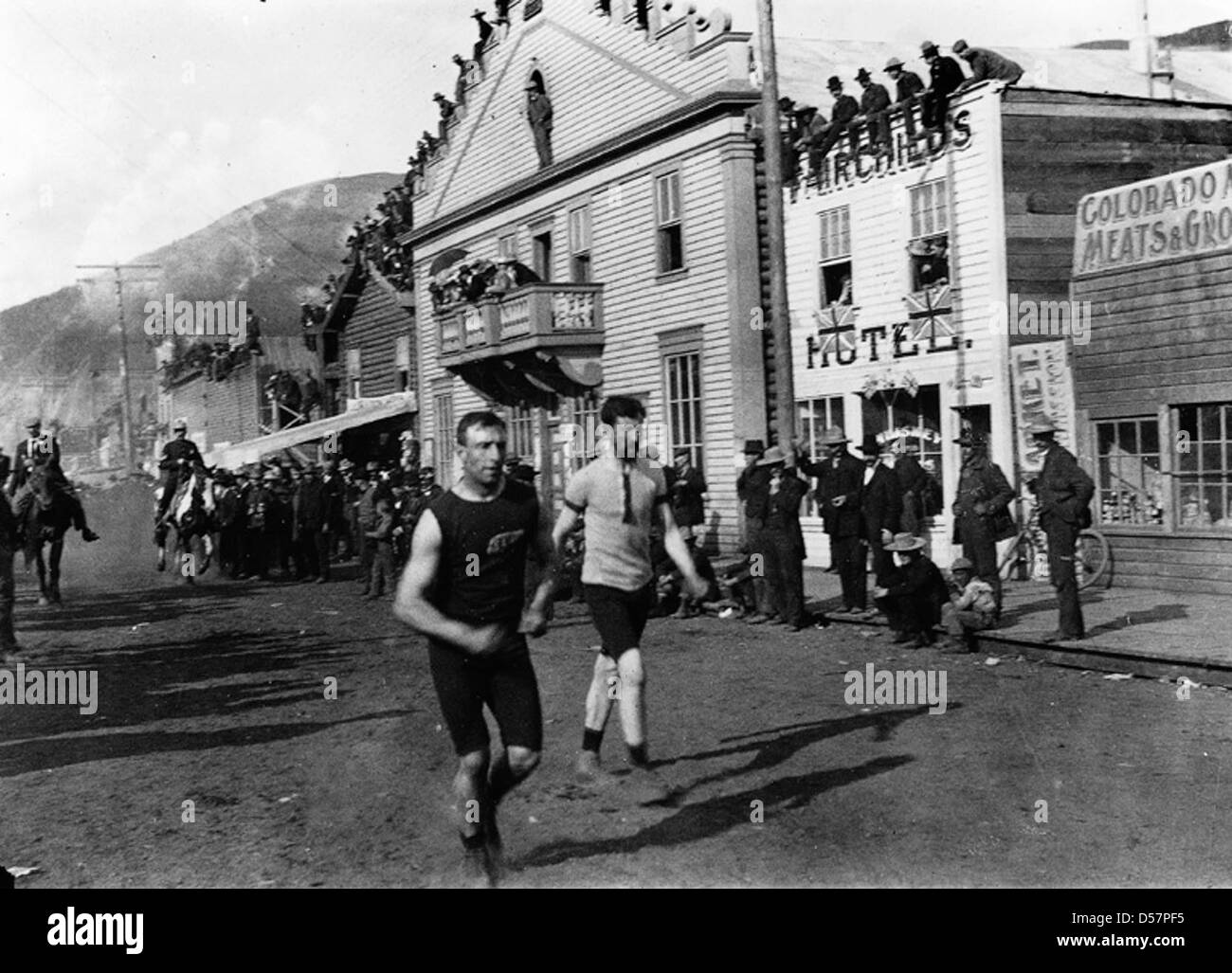 A photograph capturing a foot race in Dawson City, Yukon, around 1900 ...