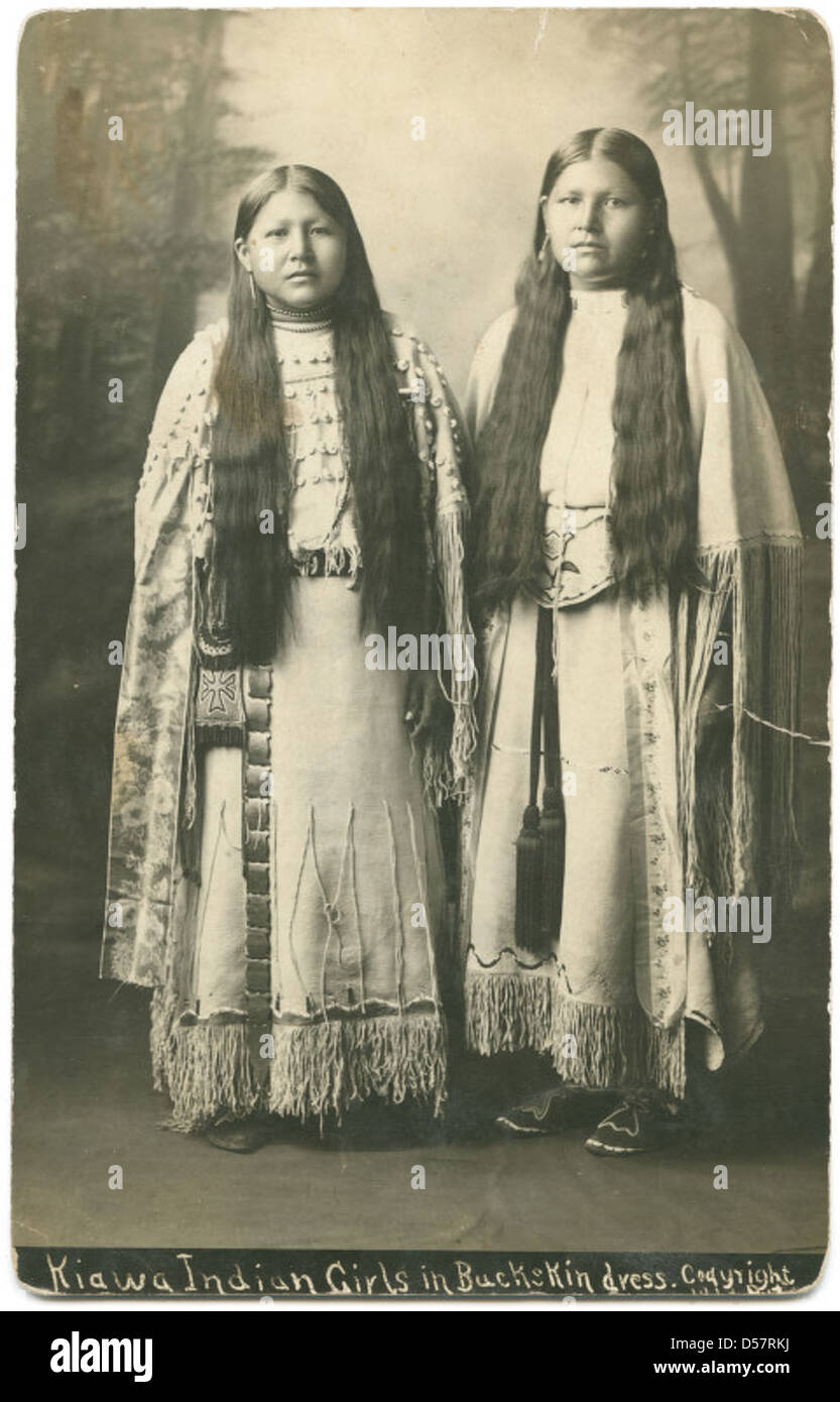 A historical photograph of Kiowa Indian girls wearing traditional ...
