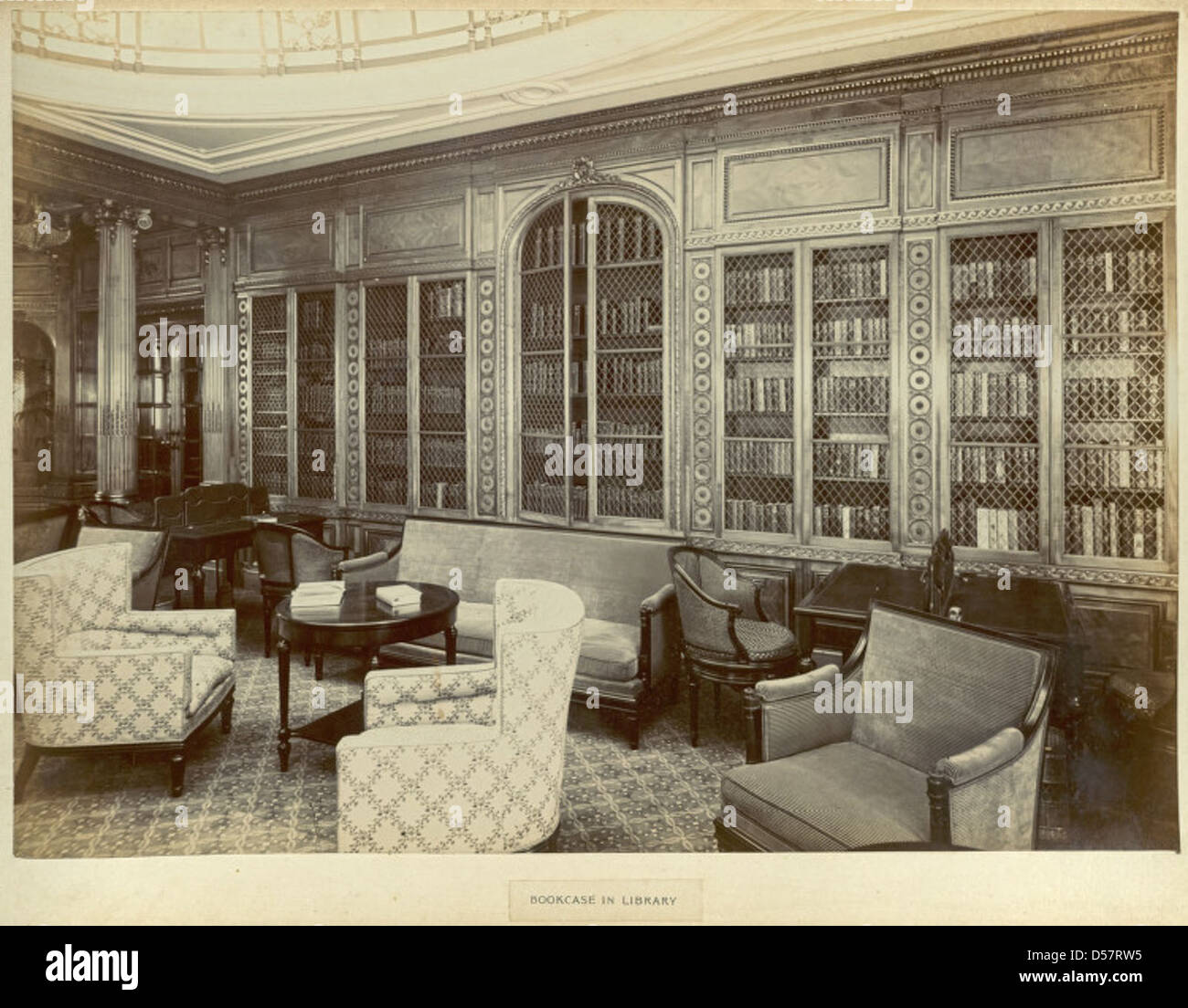 A photograph of a bookcase in the library of the RMS Mauretania ...