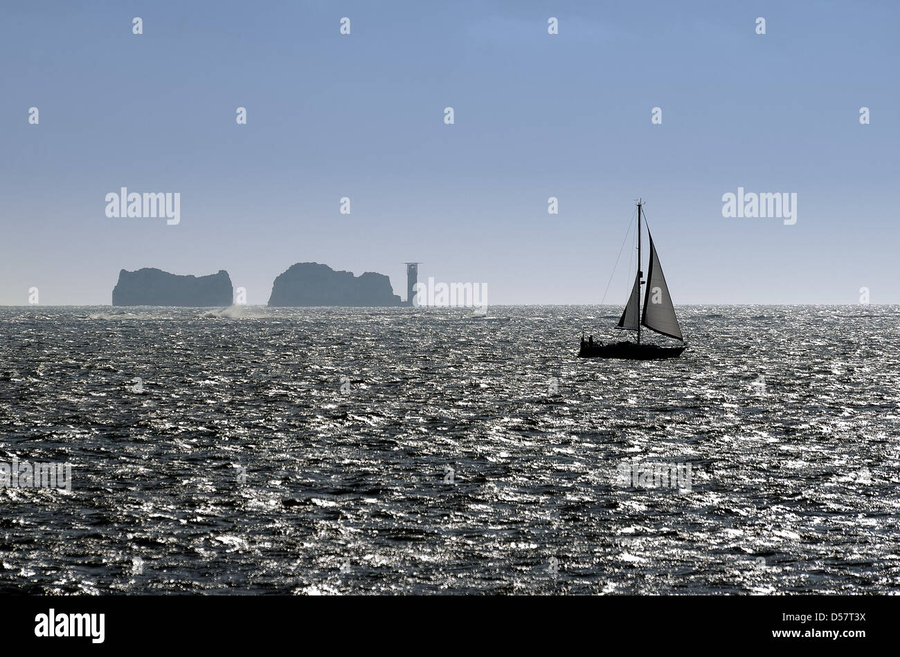 Yacht sailing by The Needles Lighthouse Stock Photo - Alamy