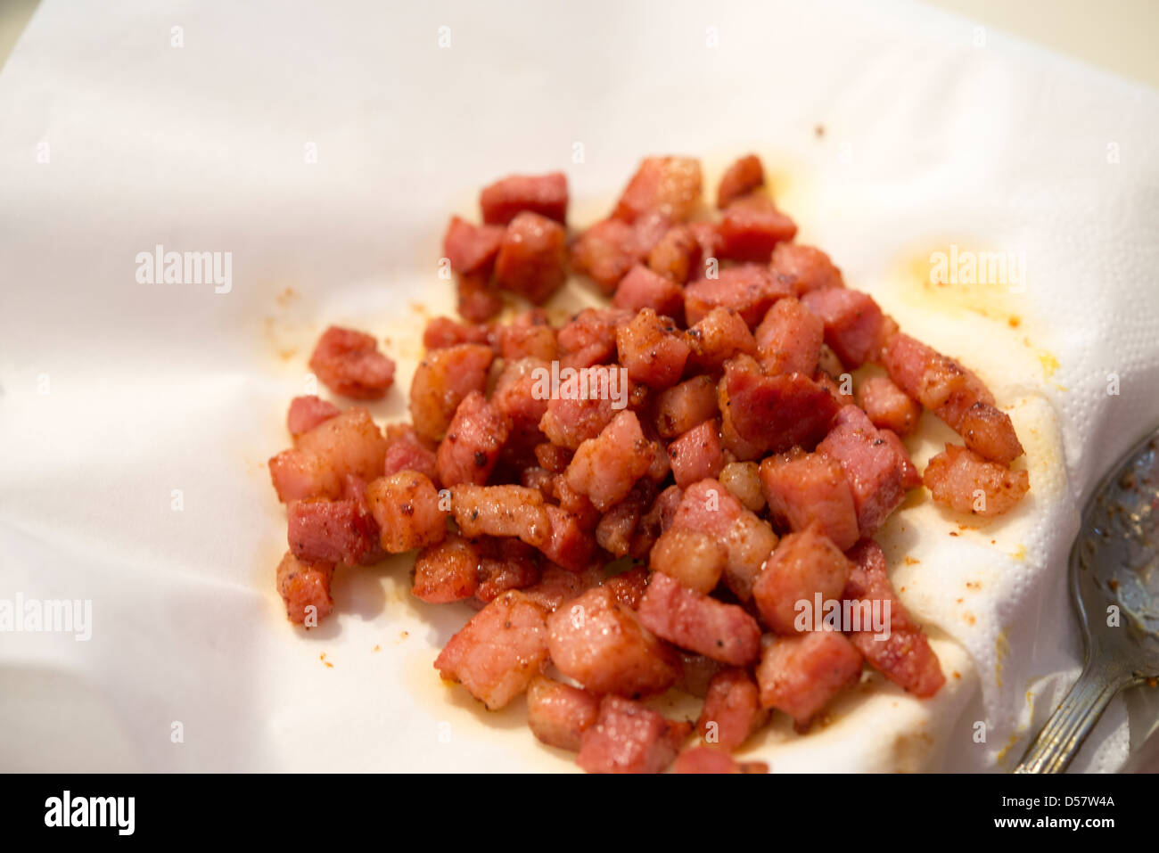 Pancetta bacon in a non-stick frying pan Stock Photo - Alamy