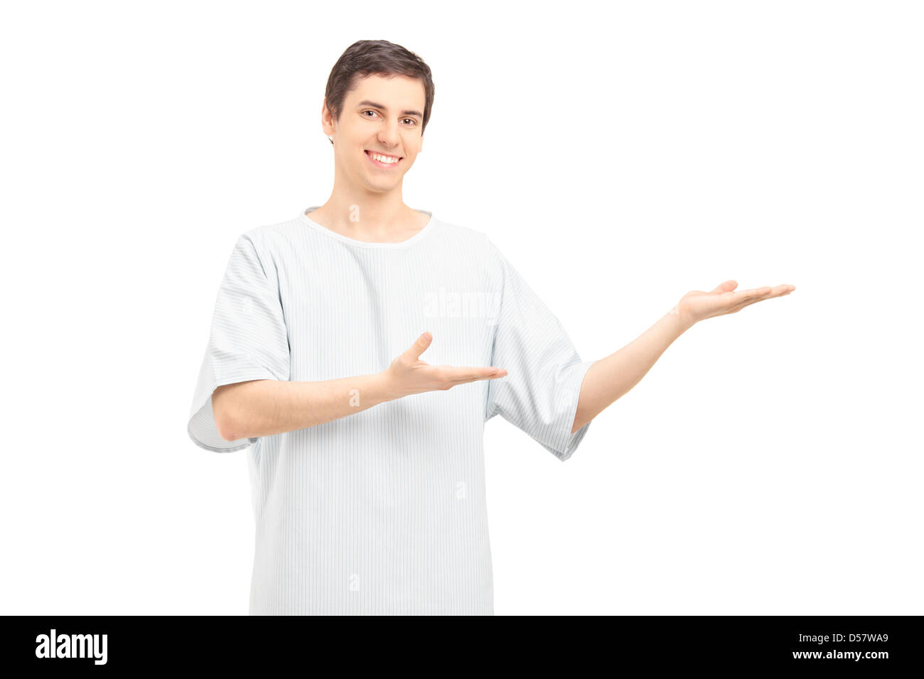 A smiling male patient showing towards something with his hands ...