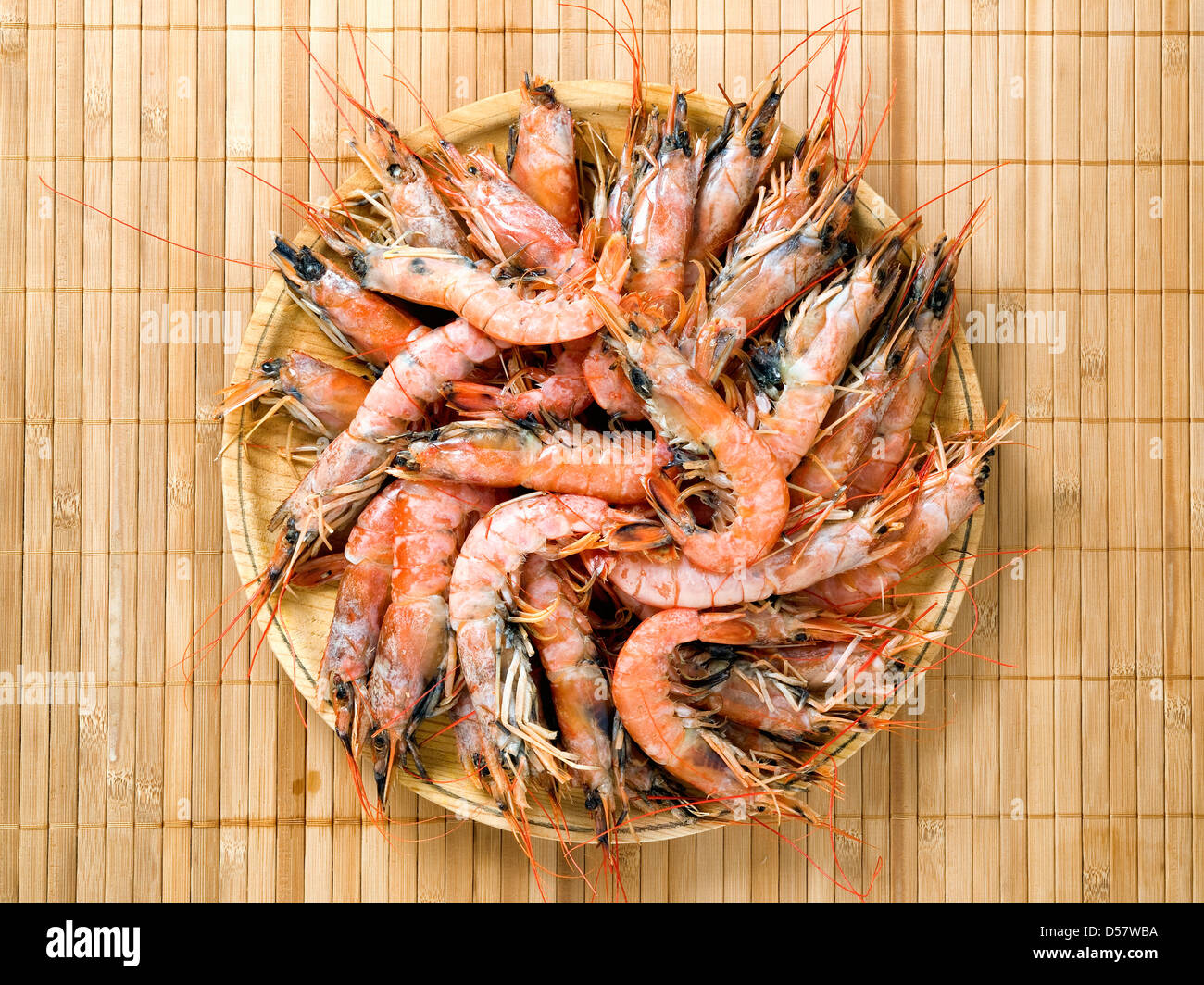 Many shrimp on a wooden plate. The seafood is a tasty and healthy Stock ...