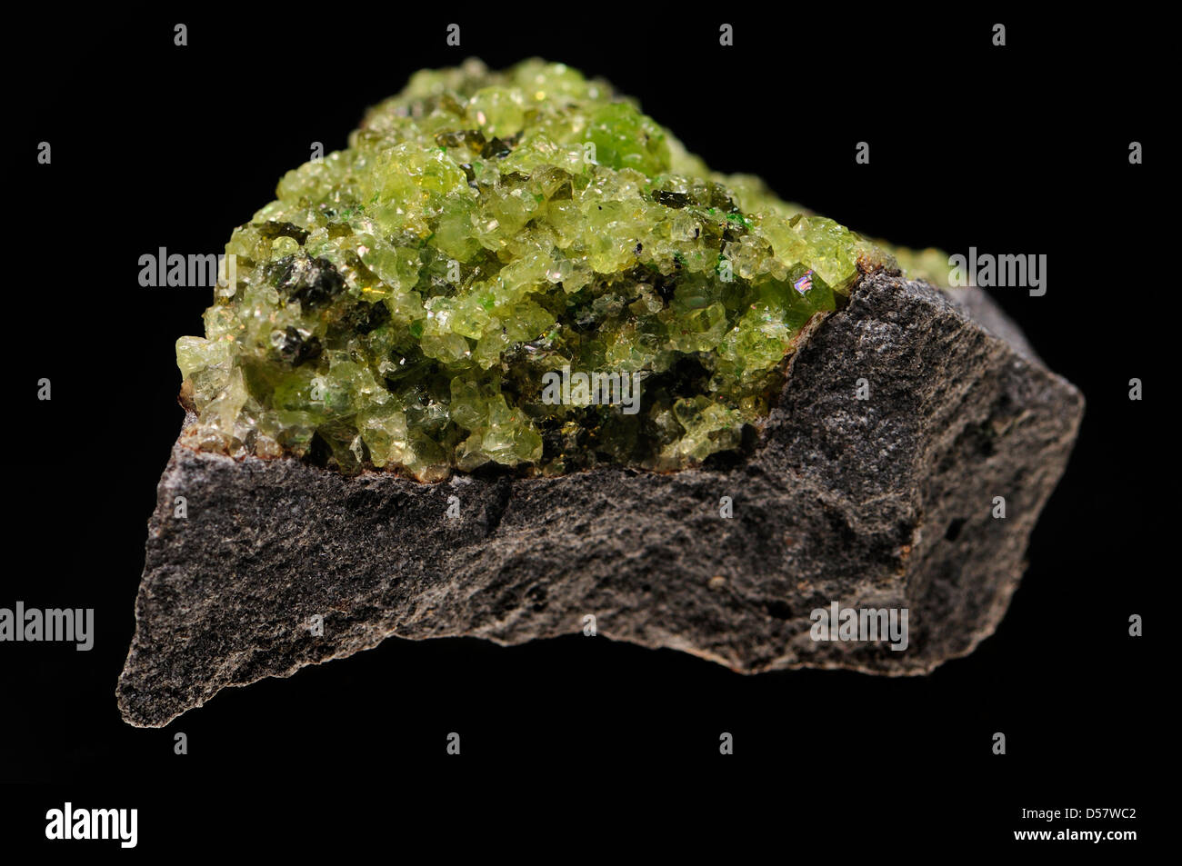 Peridot (with some darker Olivine crystals) on a matrix of Basalt, from ...
