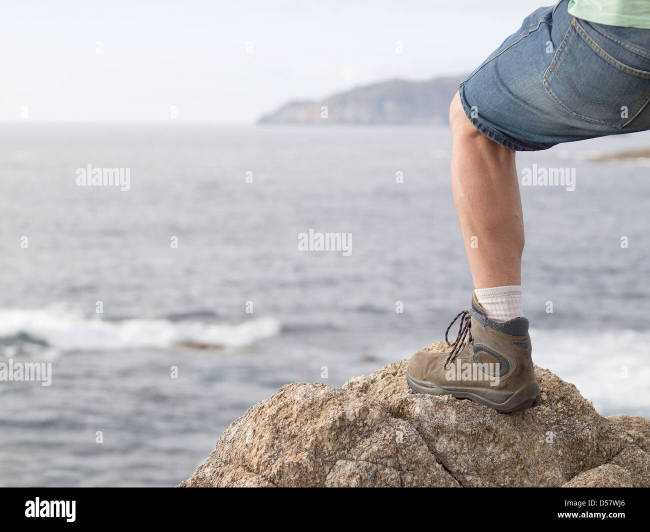 The photo shows a leg on a rock at a seascape Stock Photo - Alamy