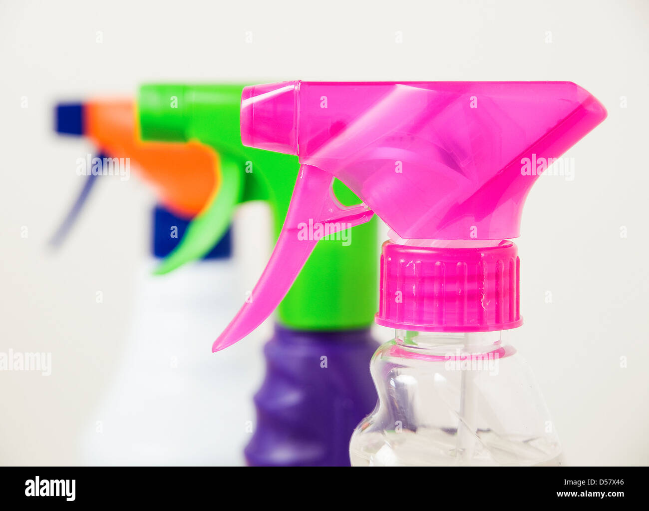 Three different colors sprayers on white background Stock Photo - Alamy
