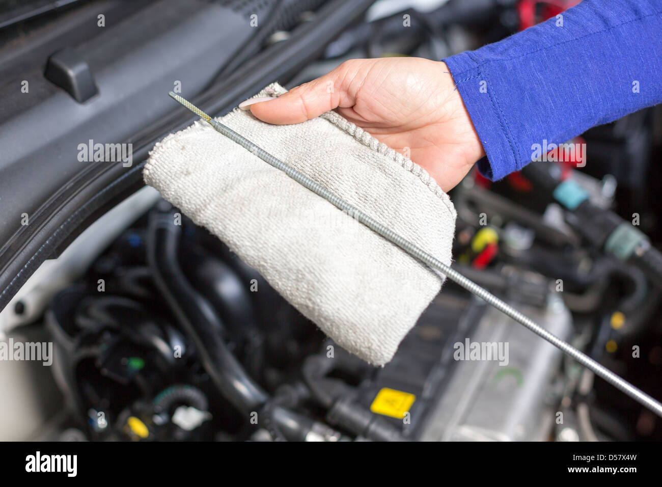 Car mechanic checking the oil of a car Stock Photo - Alamy