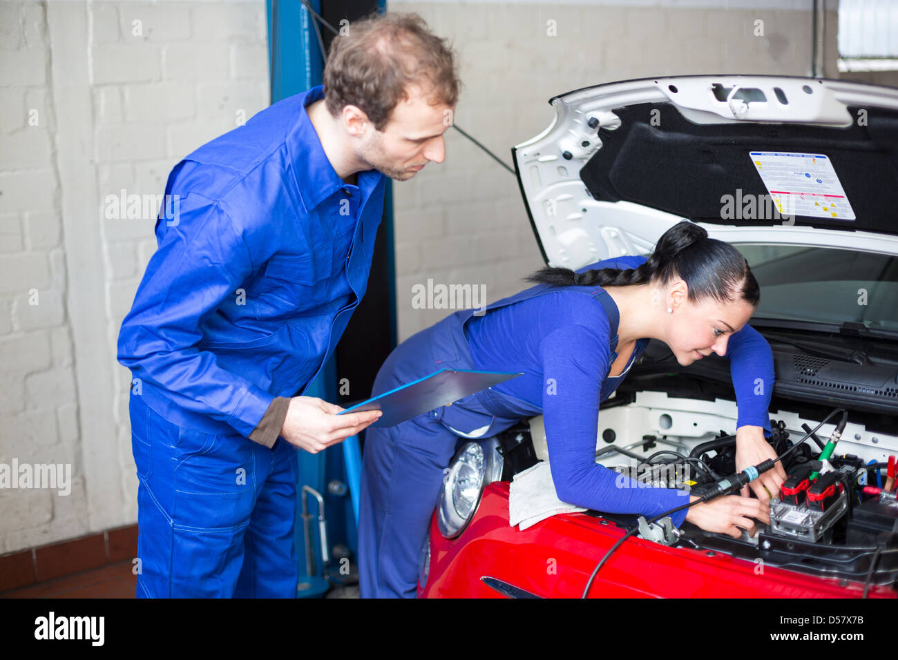 Car mechanics repairing car electrics and other parts of the motor ...