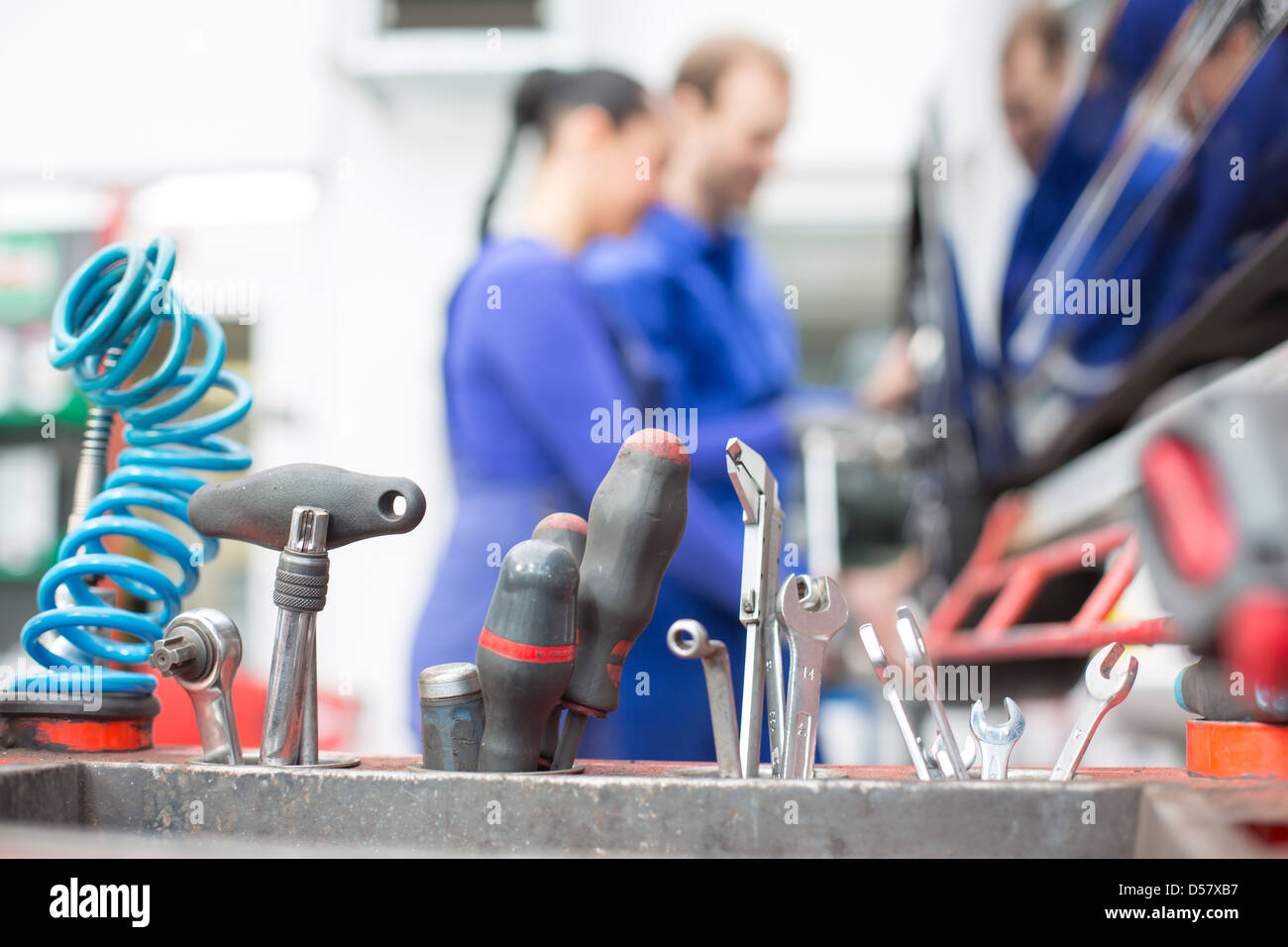 Tools in garage with mechanics working in the background Stock Photo ...