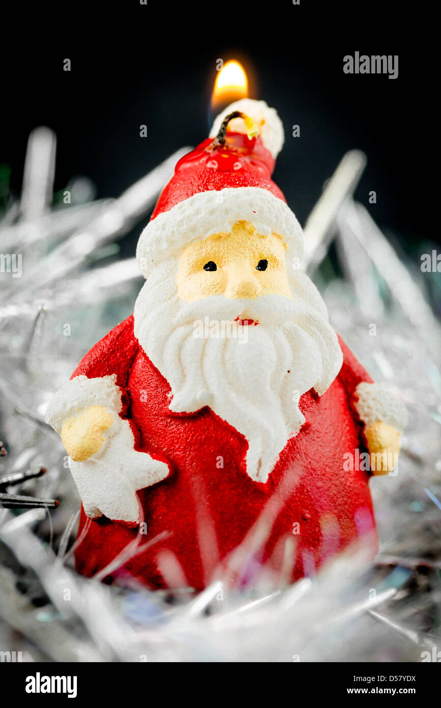 Santa Claus burning candle Stock Photo - Alamy