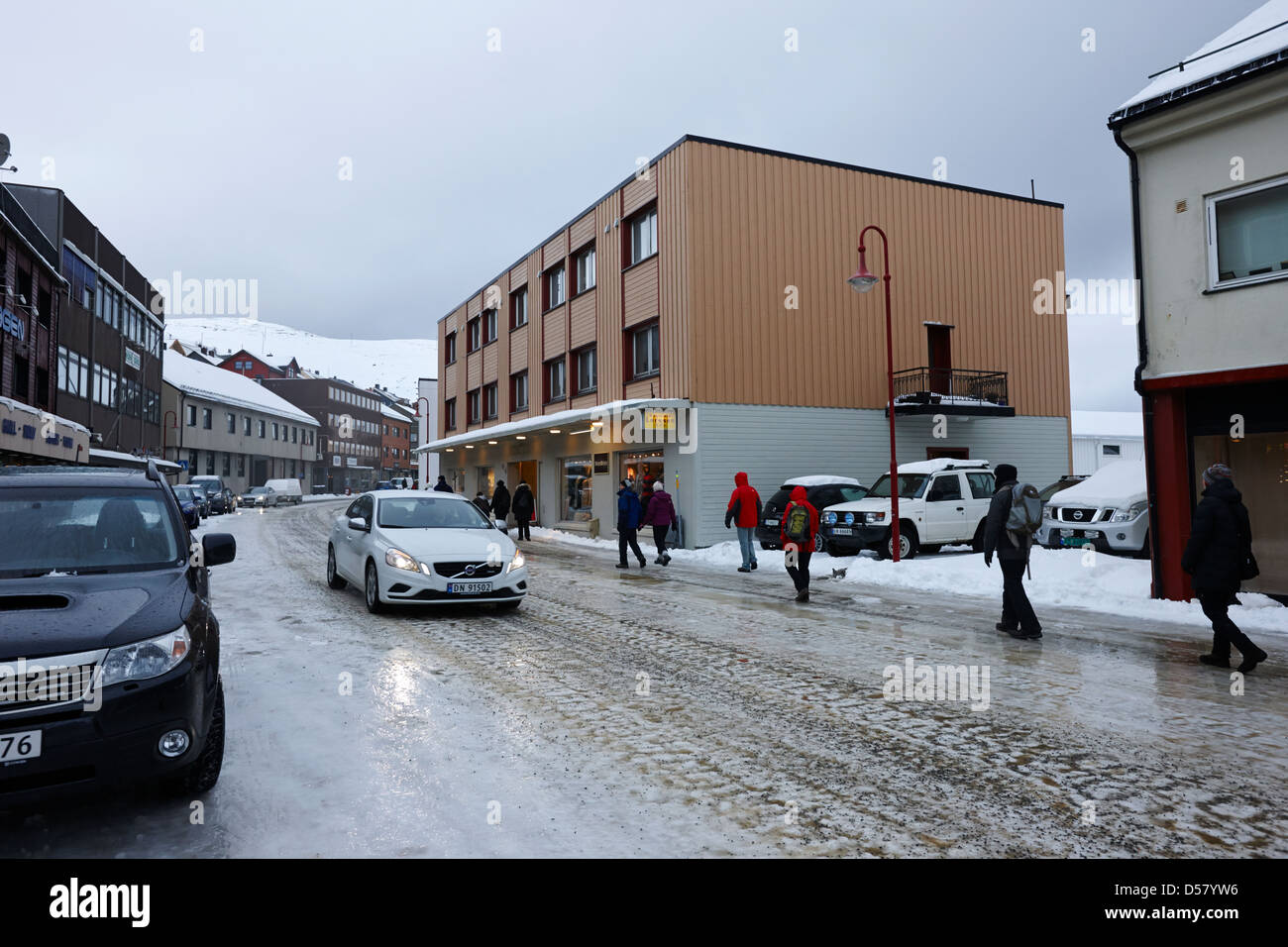 people walking along ice covered storgata main shopping street ...
