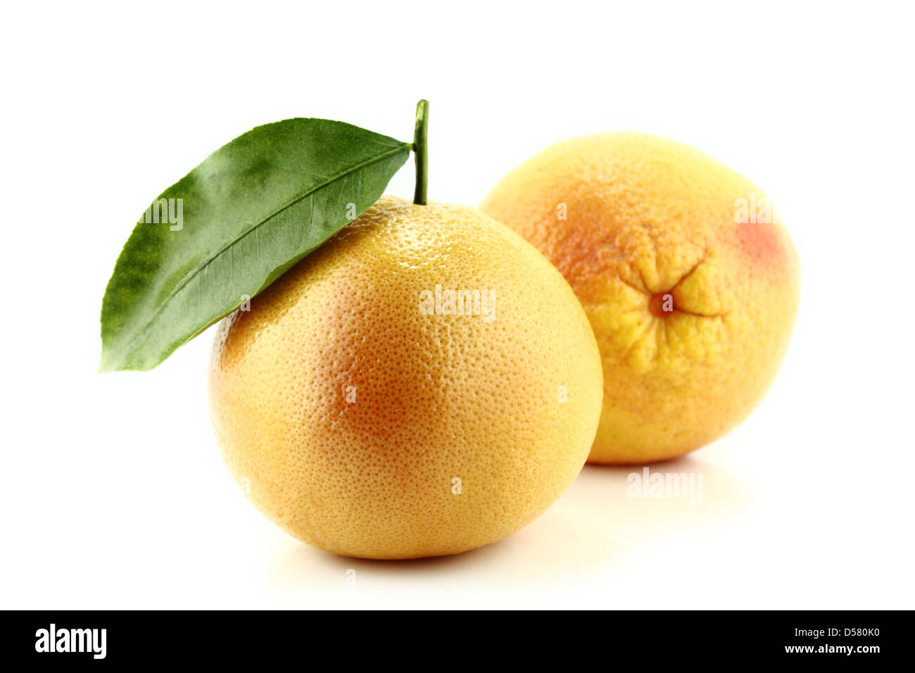 Ripe appetizing grapefruit with leaf on white background Stock Photo ...