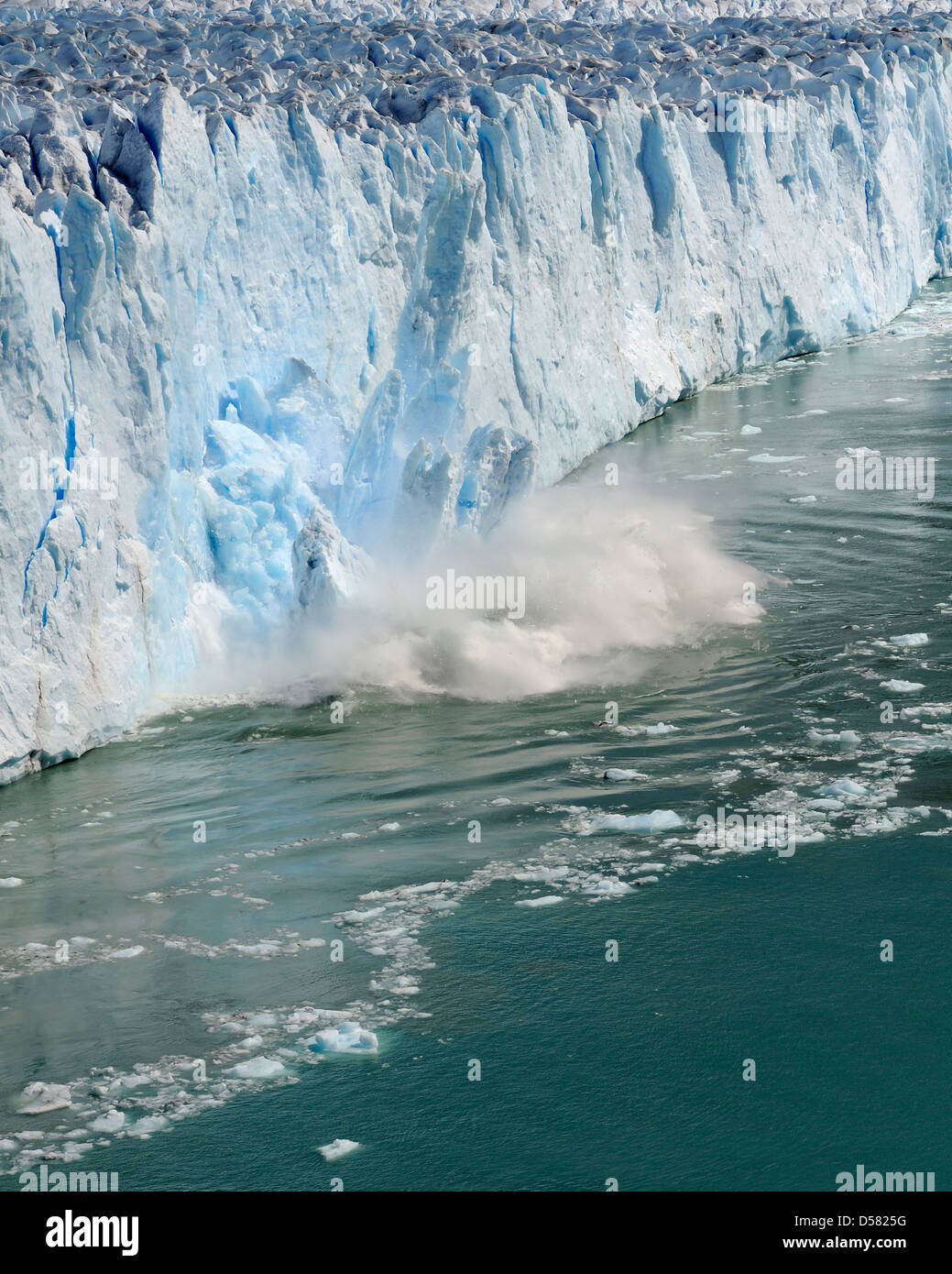 A tower of ice collapses from the face of the Perito Moreno Glacier ...