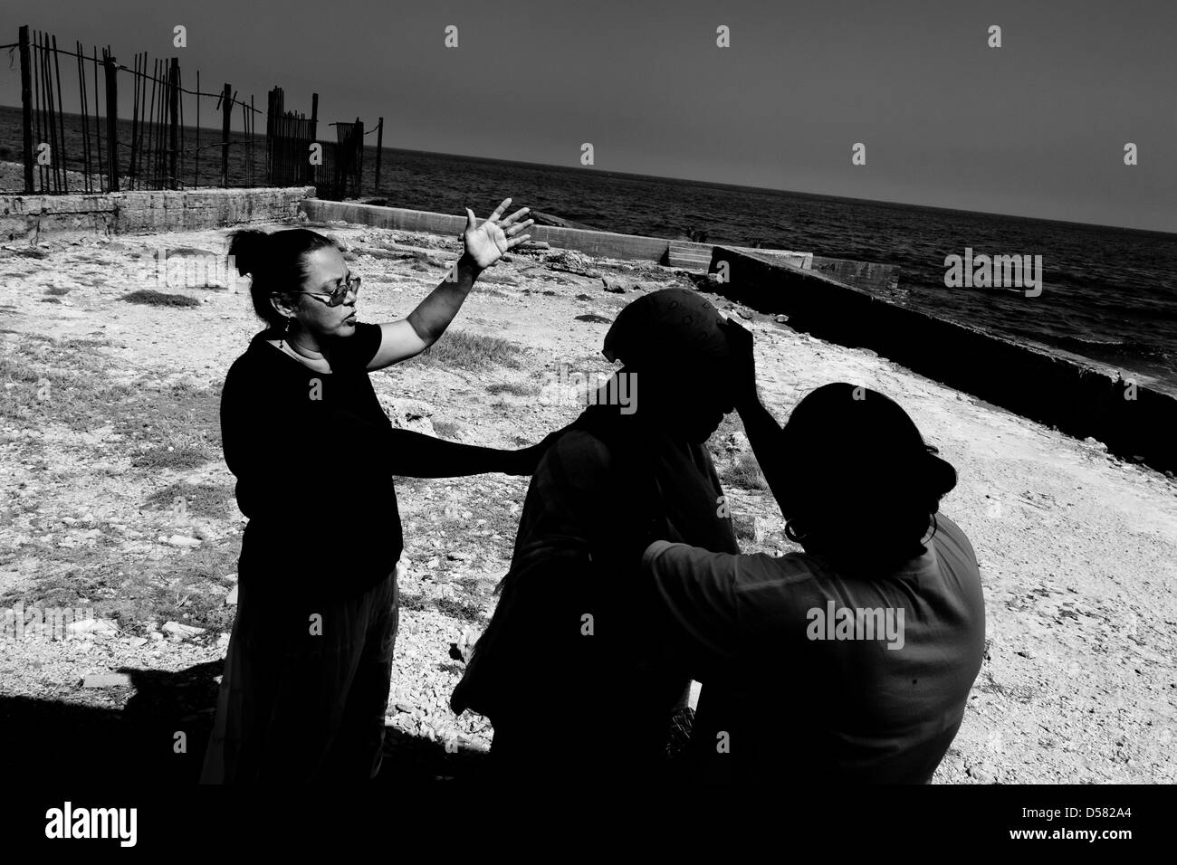 A Christian follower takes part in a baptism ritual on the beach near ...