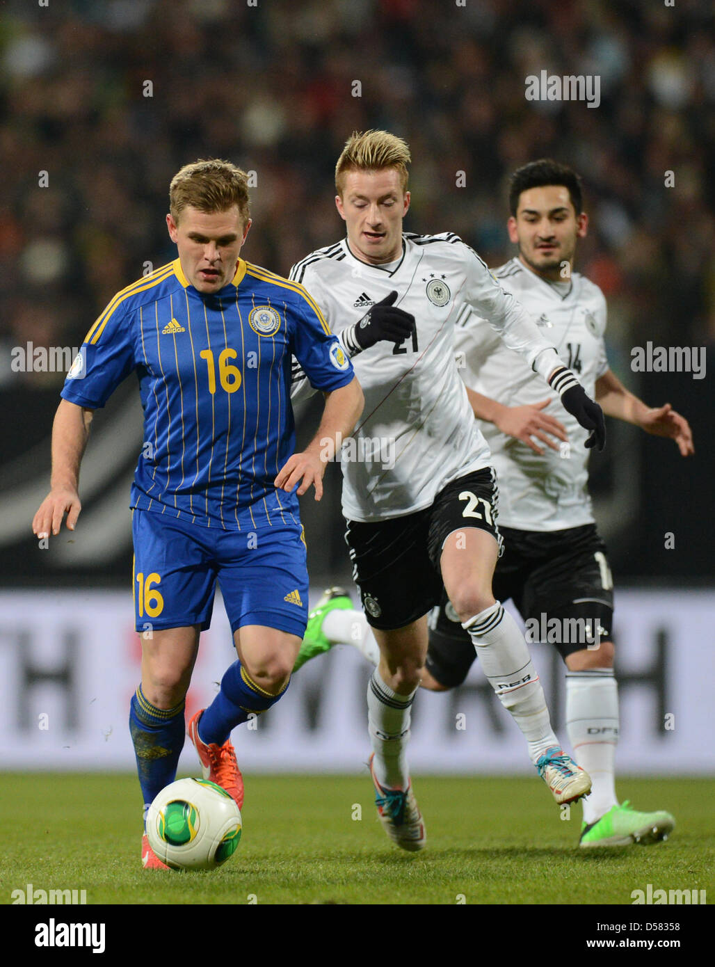 Germany's Marco Reus (C) and Kazakhstan's Genrikh Shmidtgal (L) vie for ...