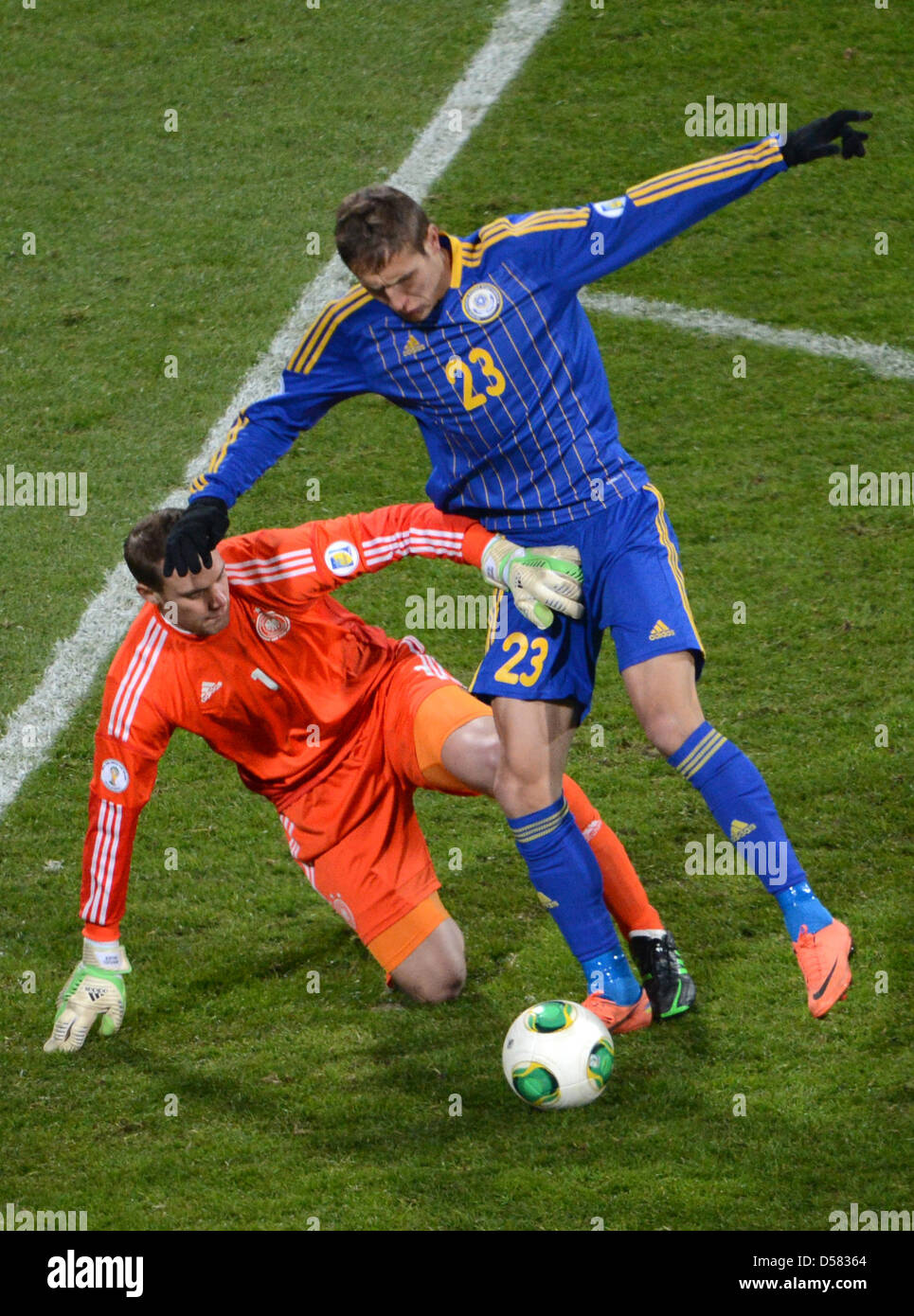 Germany's goalkeeper Manuel Neuer (L) vies for the ball with Kazakhstan ...