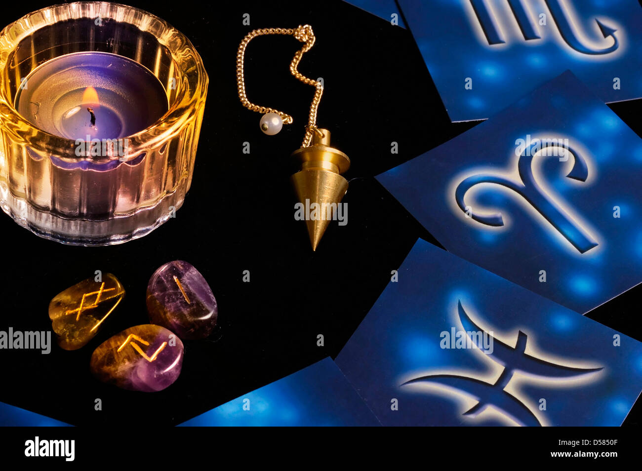 astrology pendulum and runes Stock Photo - Alamy
