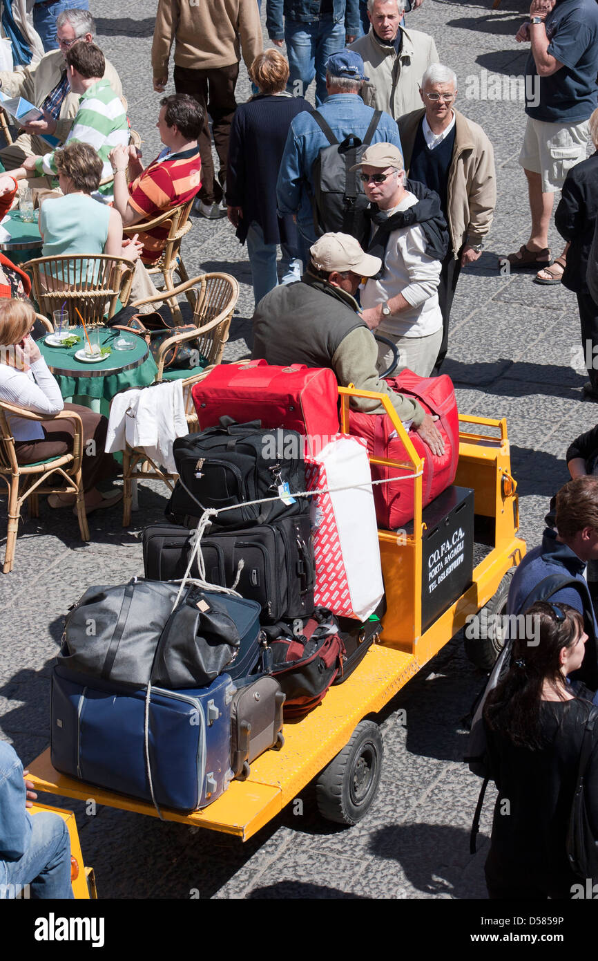 Baggage Porter makes his way through Crowded Piazza on the Island of ...