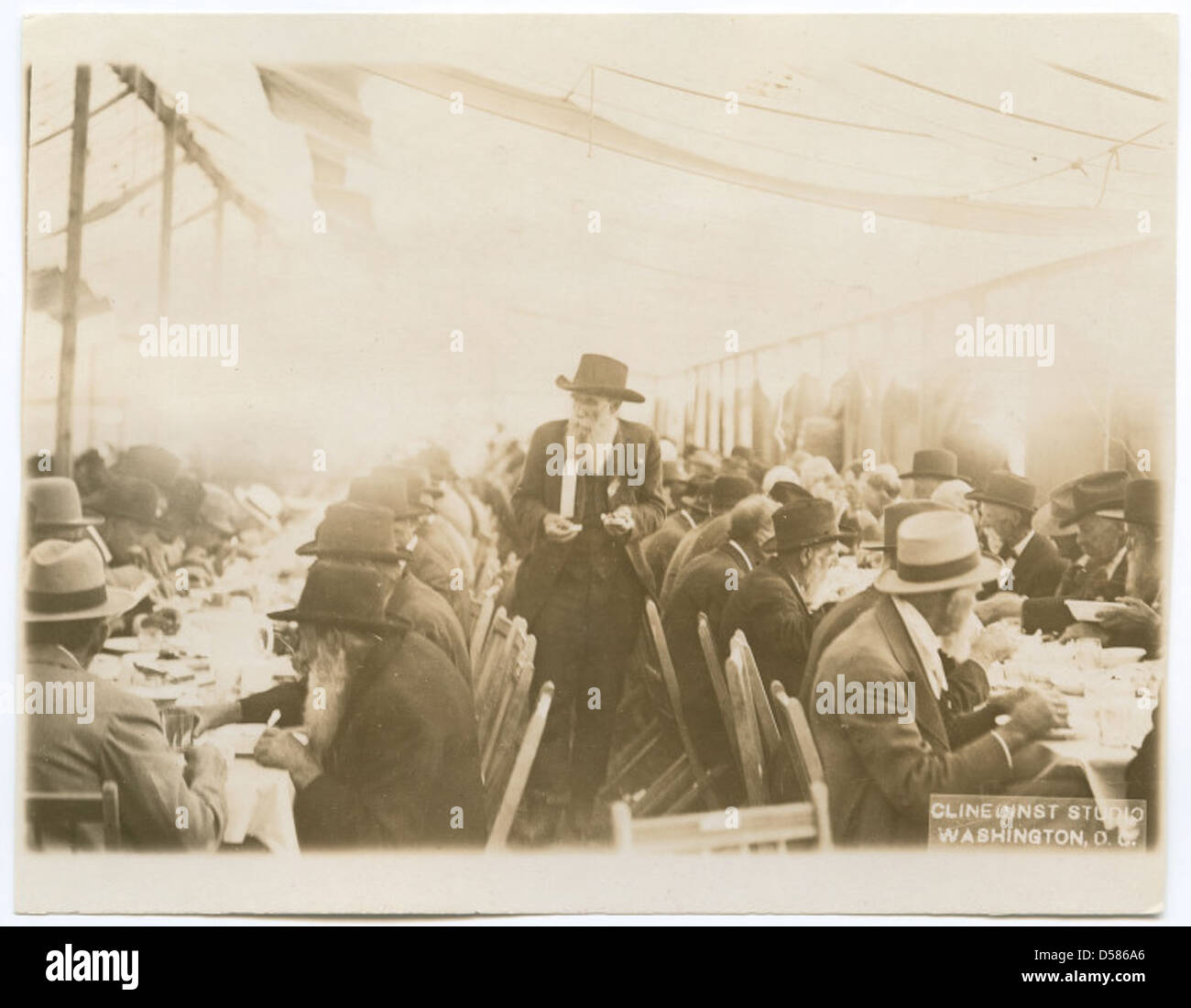 A photograph of Confederate veterans dining in a tent. The image ...