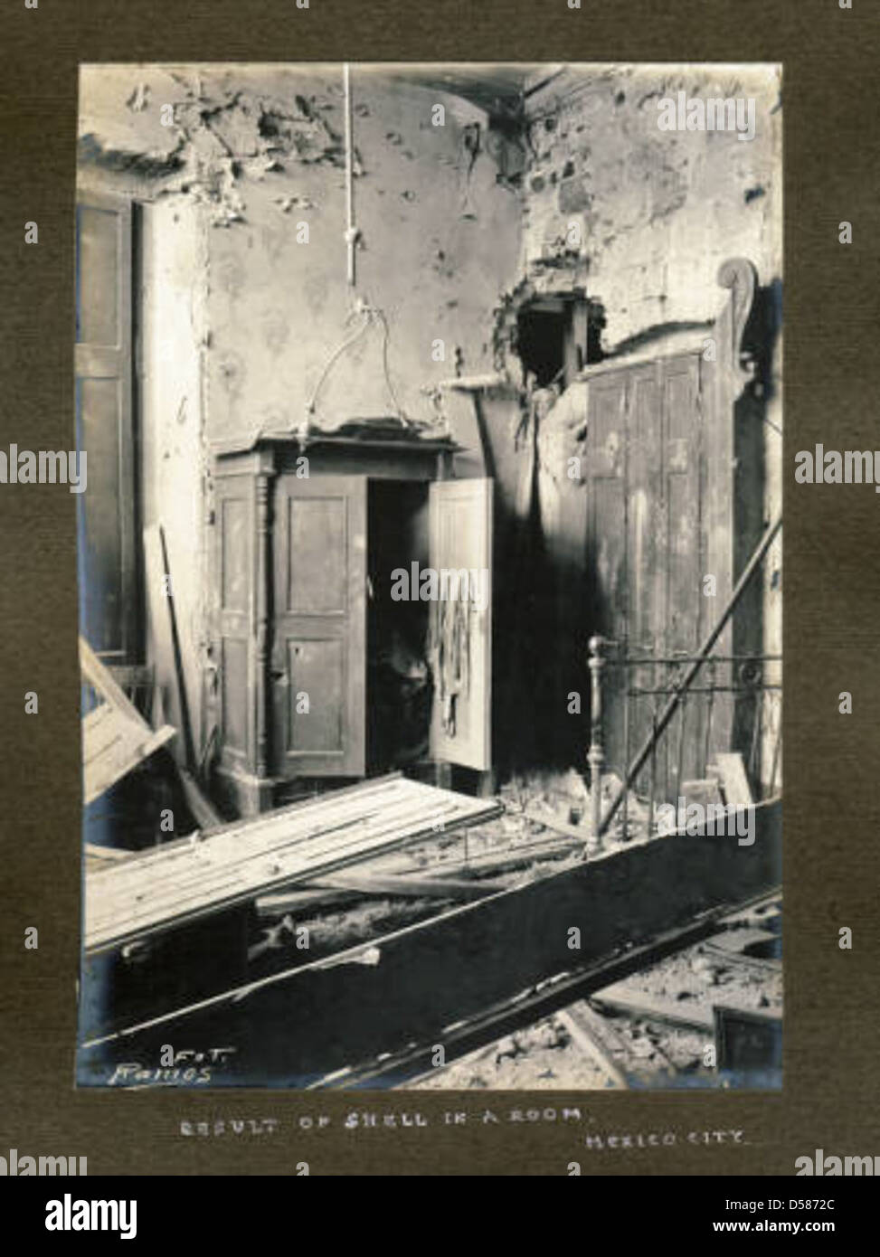 This photograph depicts the aftermath of a shell impact in a room in ...