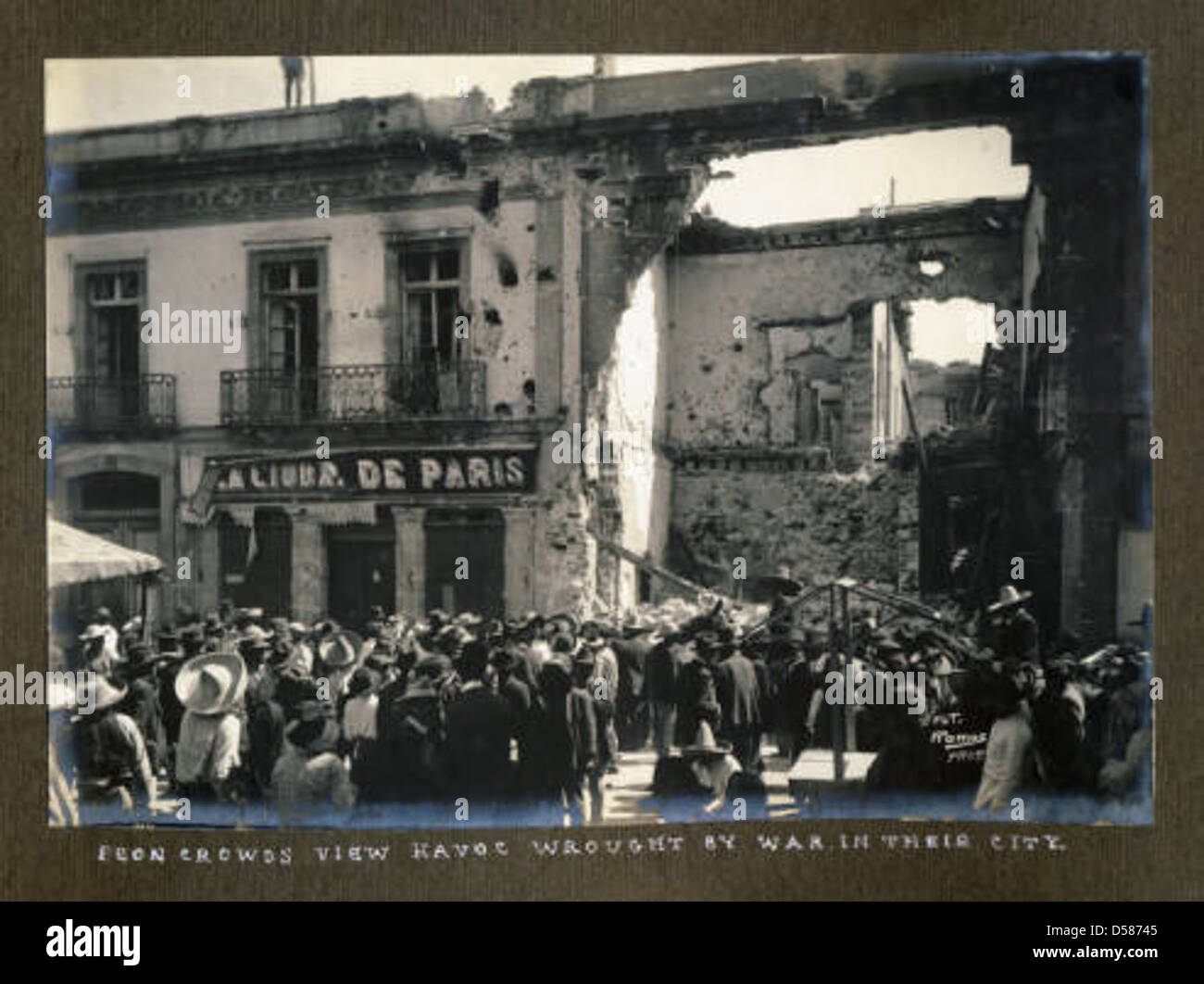 A crowd of peons in Mexico City viewing the destruction caused by war ...
