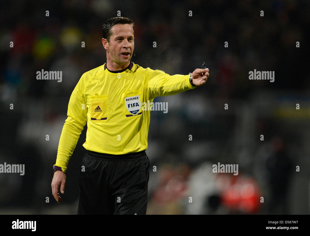 Turkish referee Halis Oezkahya gestures during the FIFA World Cup 2014 ...