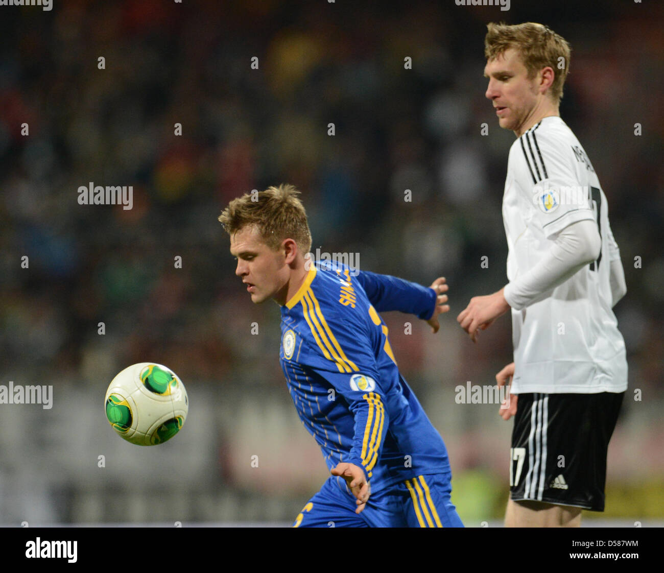 Germany's Per Mertesacker and Kazakhstan's Genrikh Shmidtgal (L) vie ...