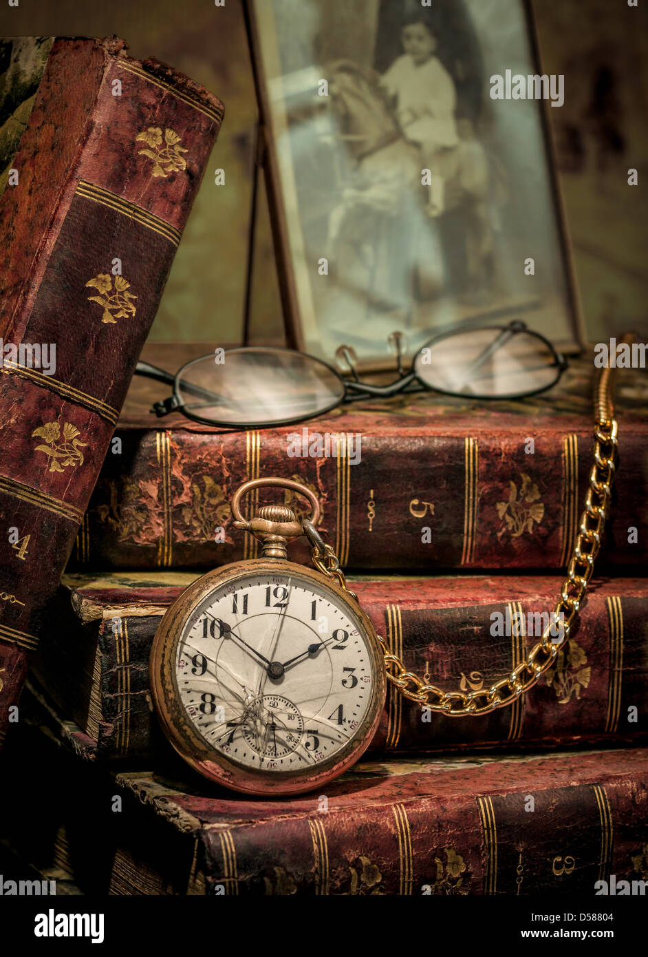 Old pocket watch and books in Low-key Stock Photo - Alamy