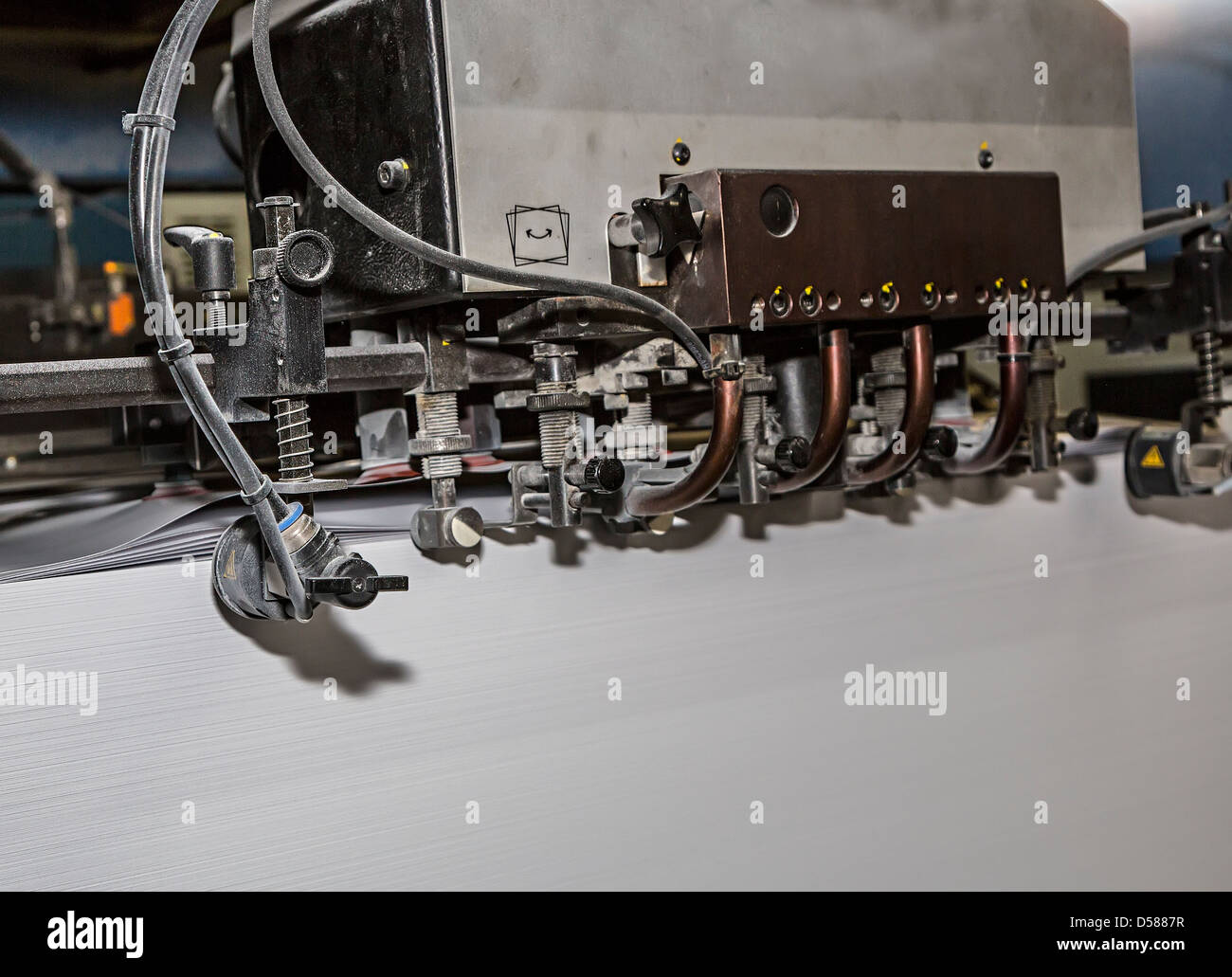 Paper pick up on offset litho printing press by blowing air between ...