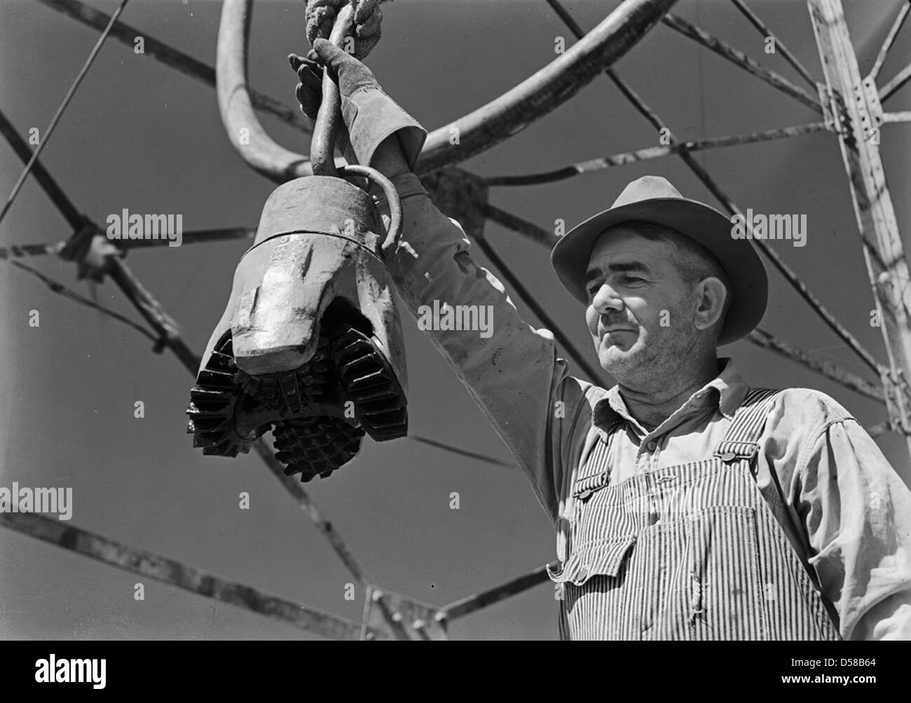 A Reed rock bit being swung to the derrick floor of a petroleum ...